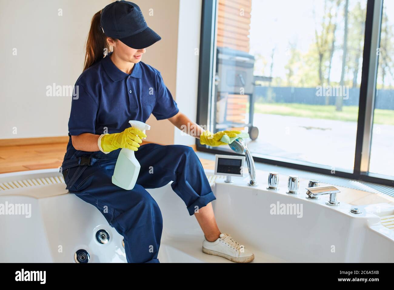 Young caucasian woman janitor cares about new house. Spring general ...