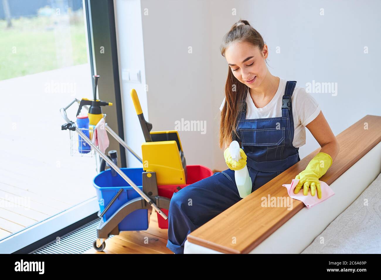 Woman wearing gloves diligently cleaning hi-res stock photography and ...