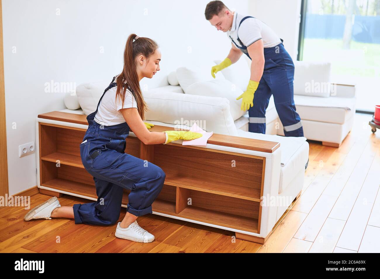 Perfect cleaning. Two janitors in uniform prepare house for new tenant ...