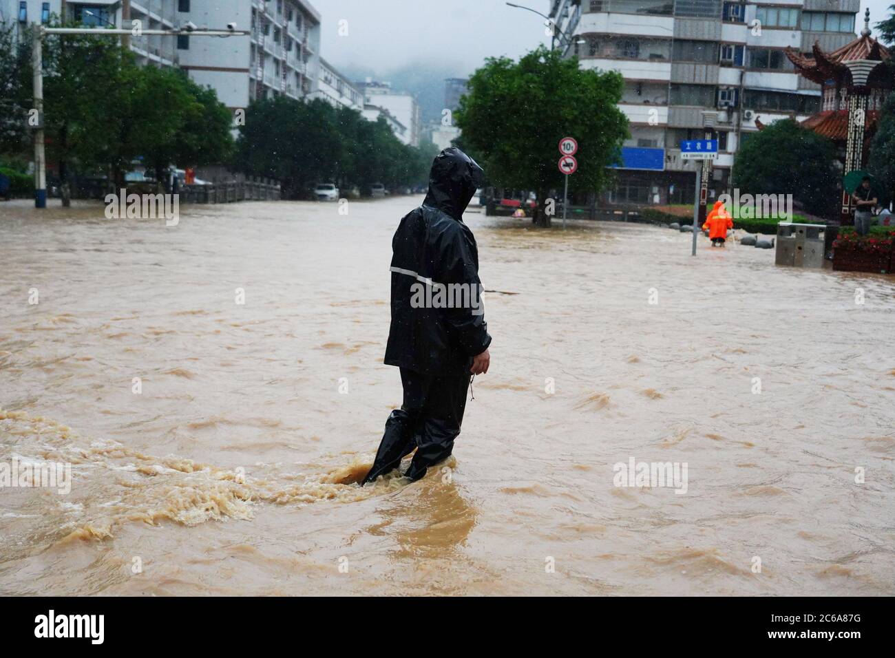 Nanchang, China's Jiangxi Province. 8th July, 2020. A man wades through ...