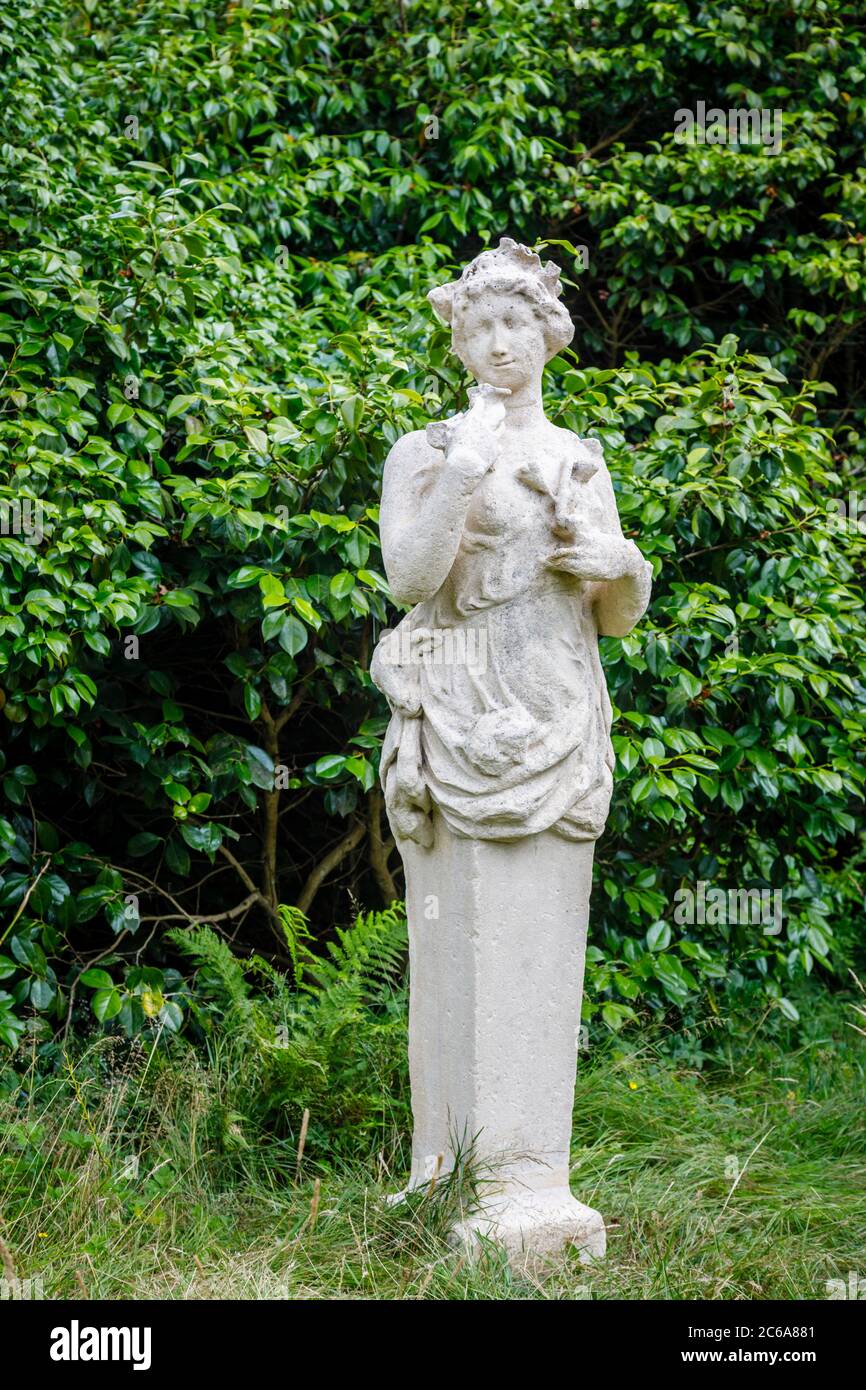 Classical slightly eroded vintage stone statue of a female nymph or ...