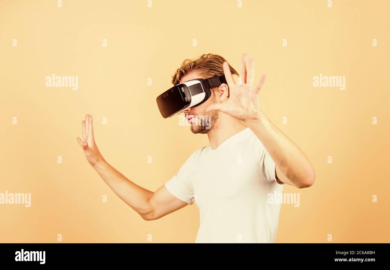 Explore cyber space. Man hipster virtual reality headset on peach ...
