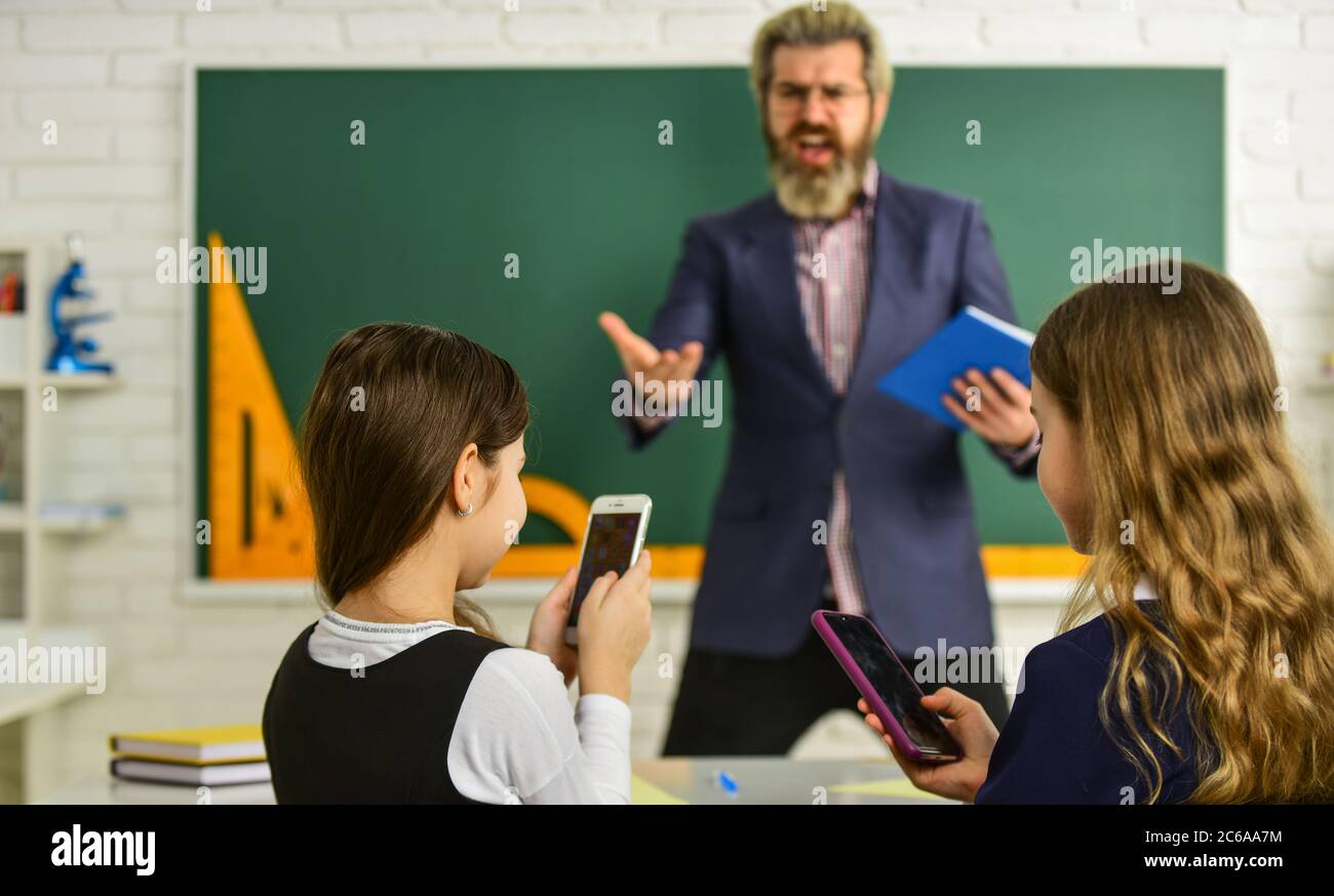 School students and teacher. Problem of smartphones in schools. Have ...