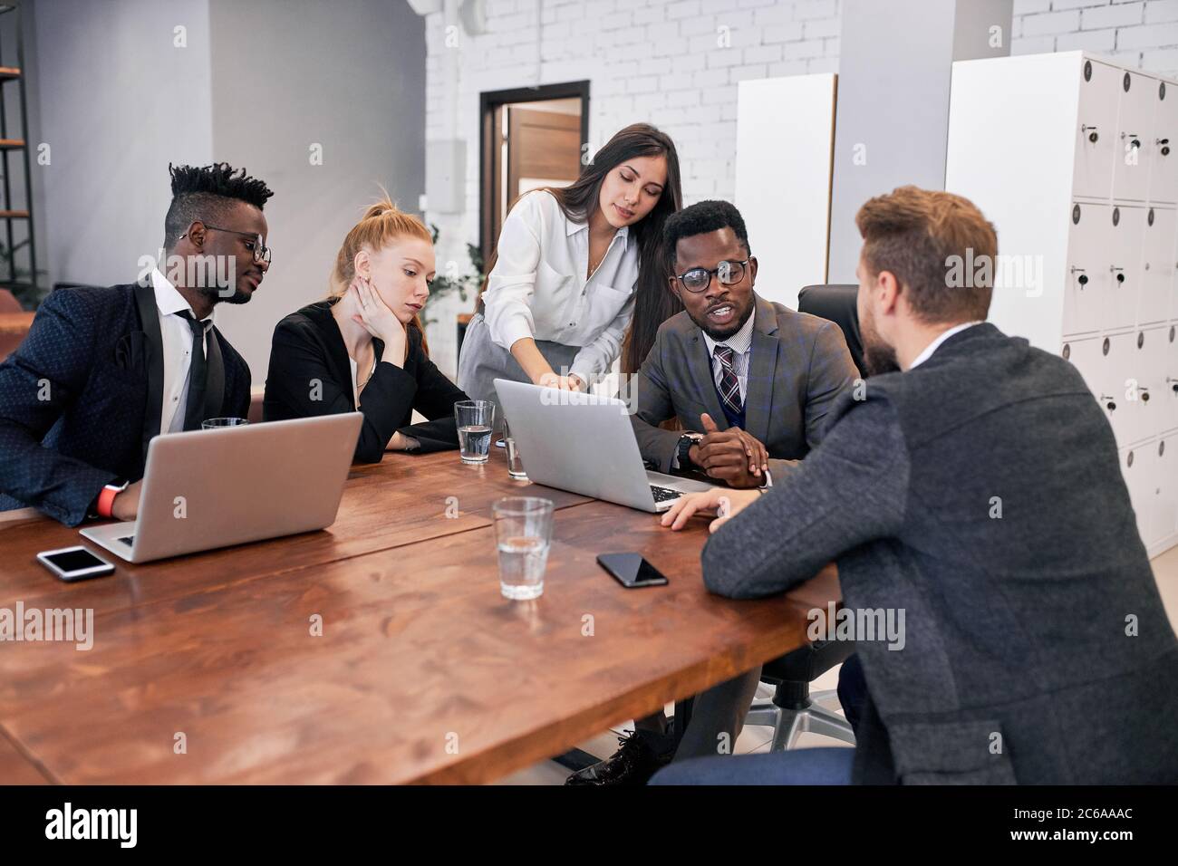 Personable african man representing his own project to young business ...