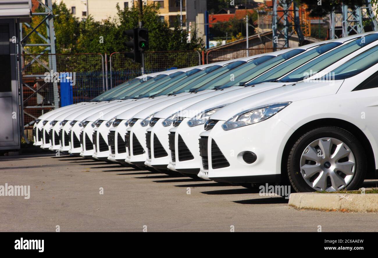 white cars are lined up in the parking lot in one line Stock Photo - Alamy