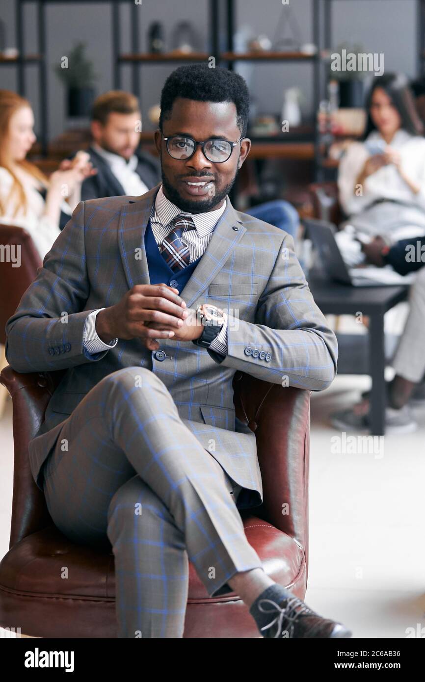 Personable man of african appearance wearing grey formal suit look at ...