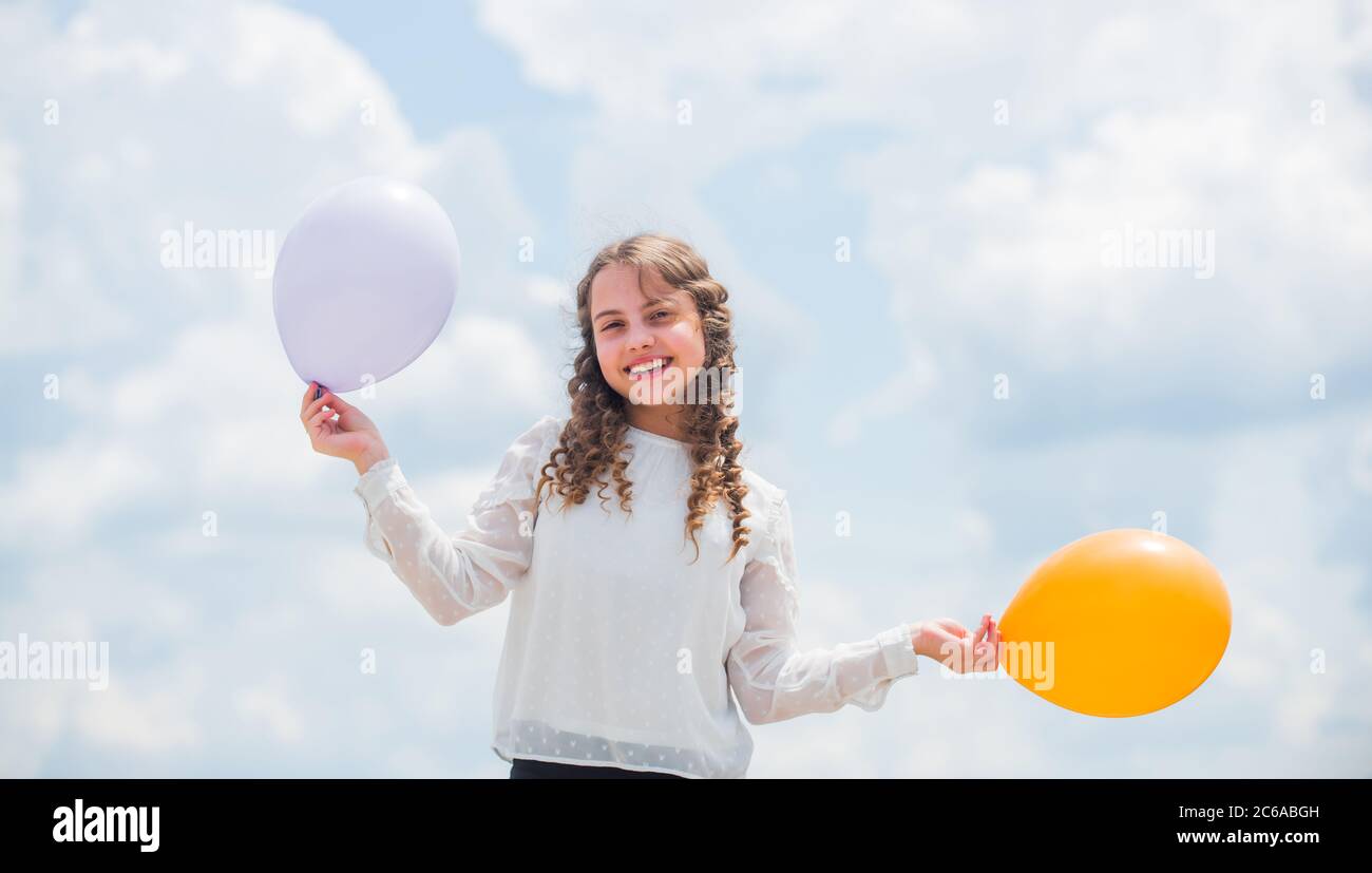 Happy child with colorful air balloons over blue sky background ...