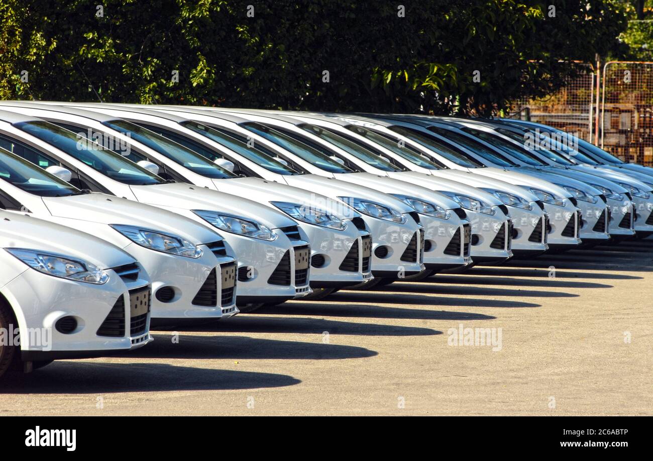 white cars are lined up in the parking lot in one line Stock Photo - Alamy