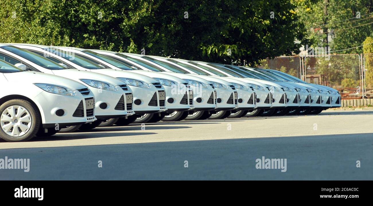 white cars are lined up in the parking lot in one line Stock Photo - Alamy