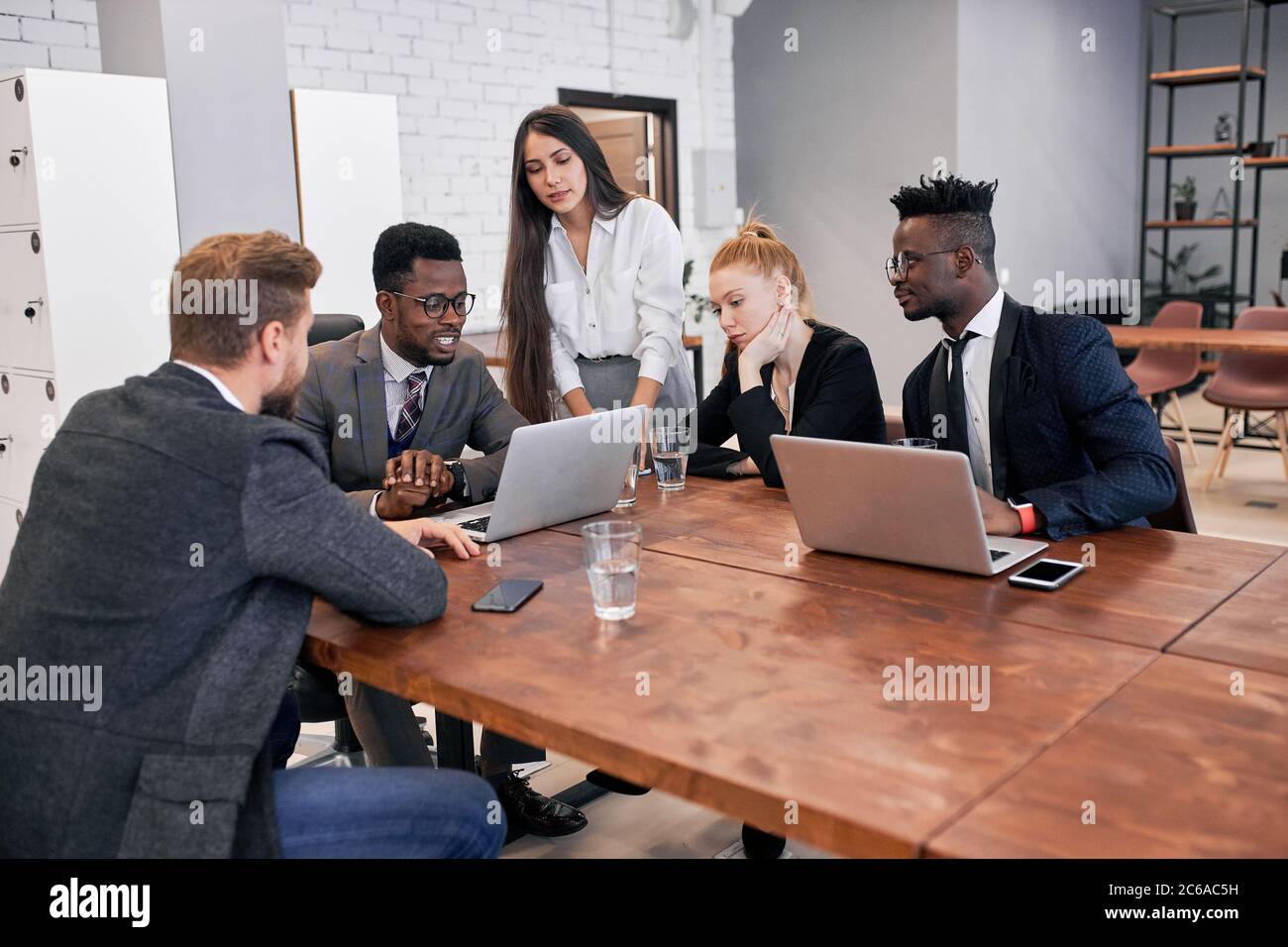Personable african man representing his own project to young business ...