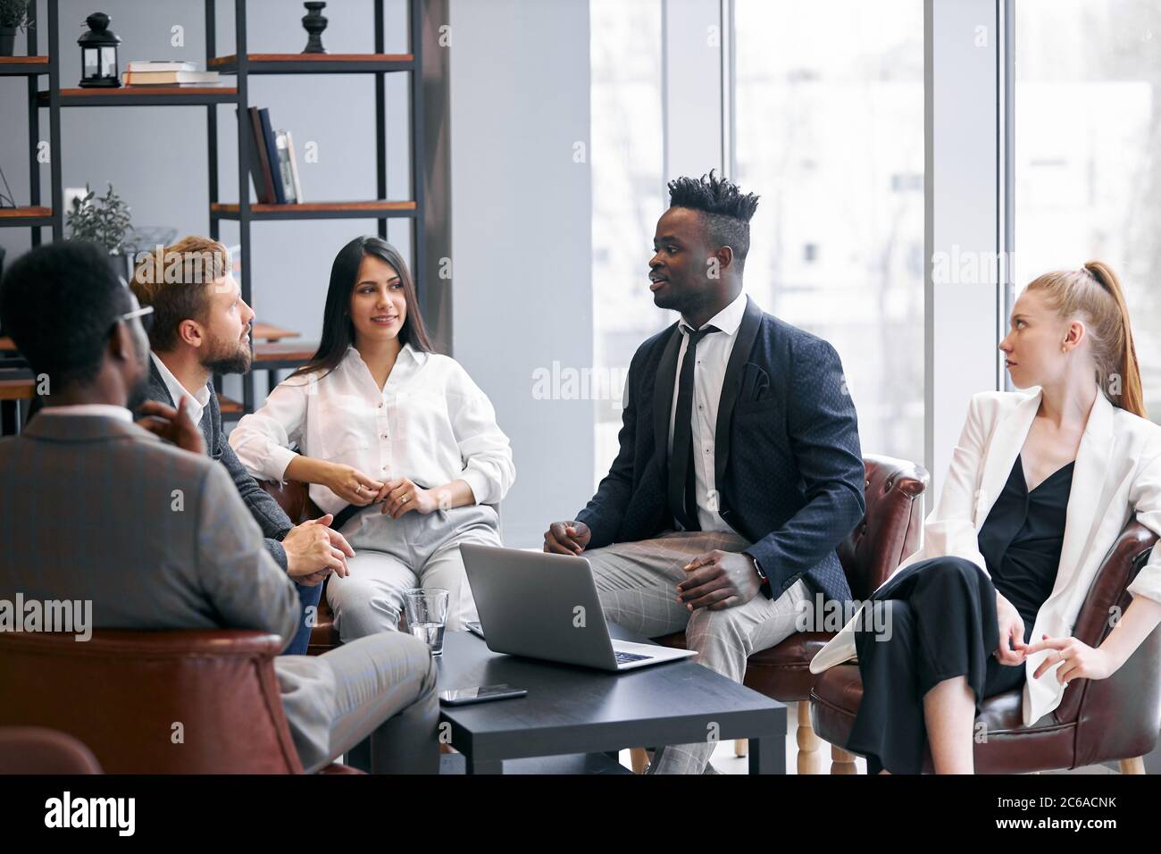 black business coach explaining project strategy to caucasian and ...