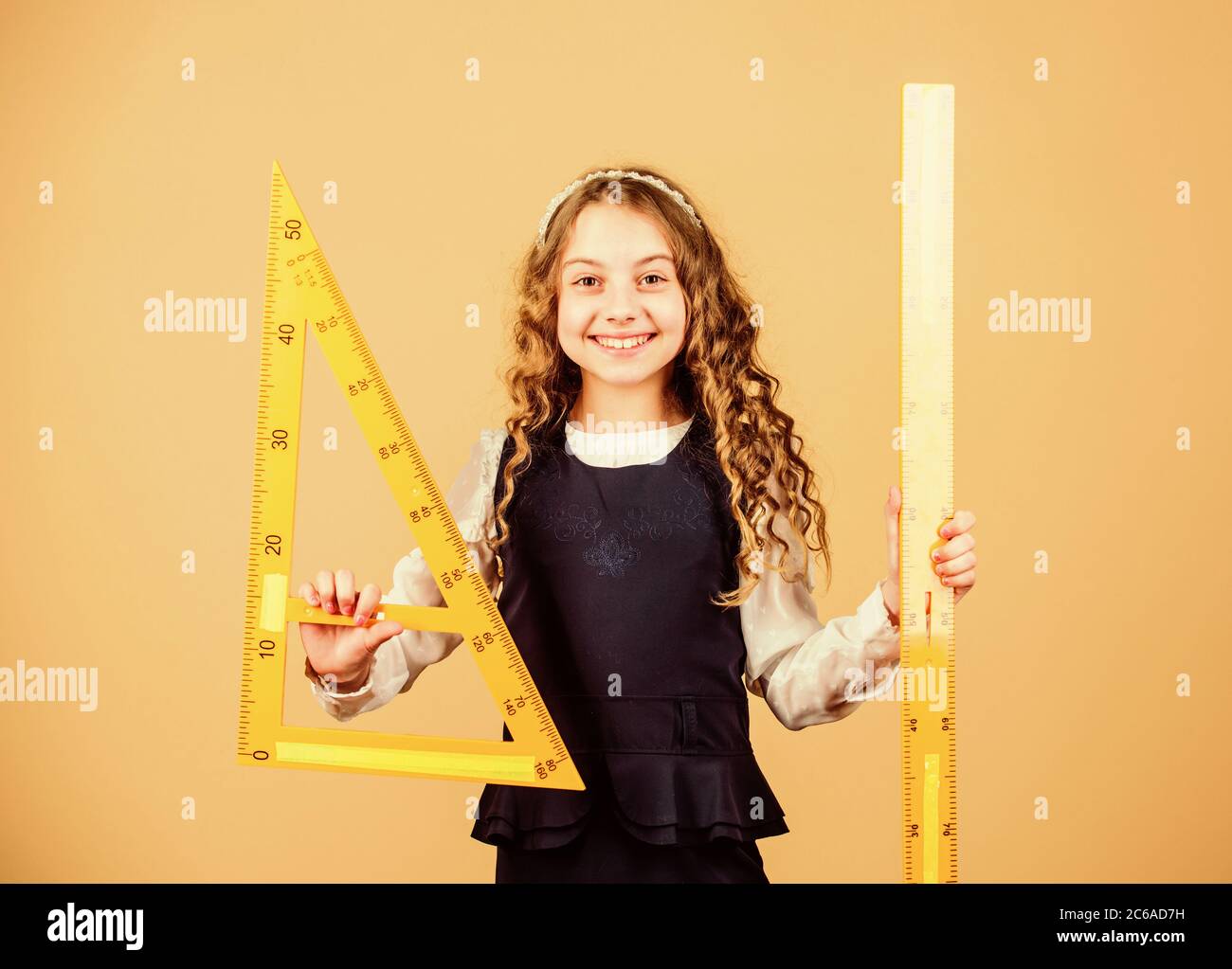 Pupil girl with big rulers. STEM school disciplines. math lesson ...