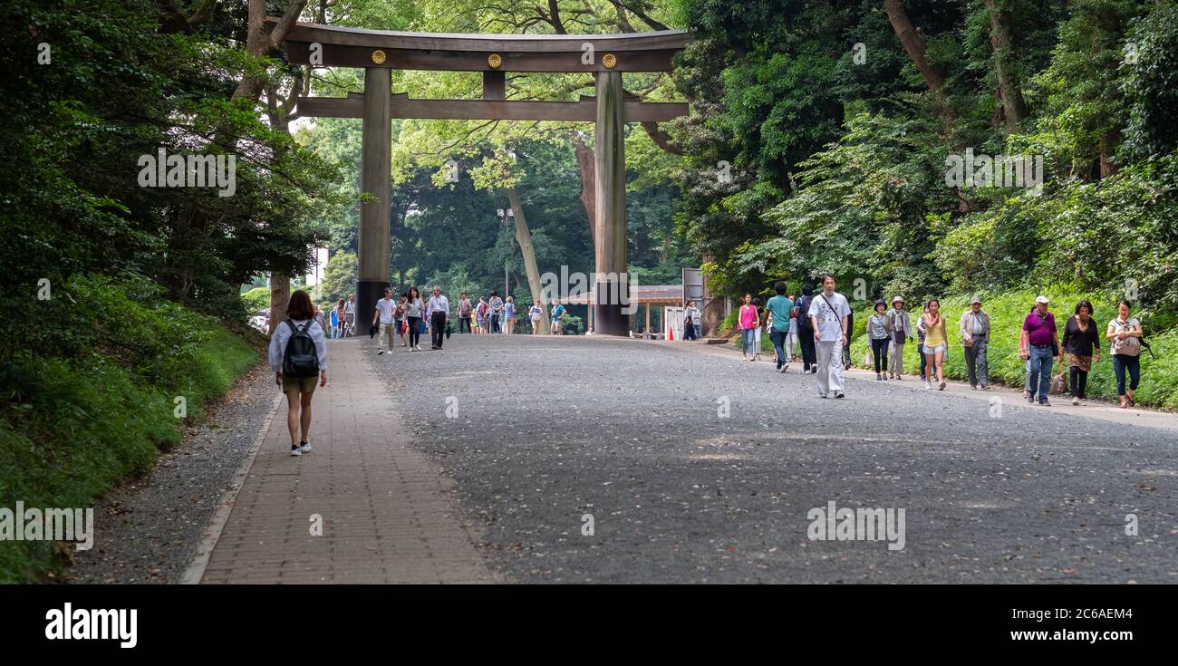 Tourists and visitors walking pass by the huge wooden Torii gate in ...