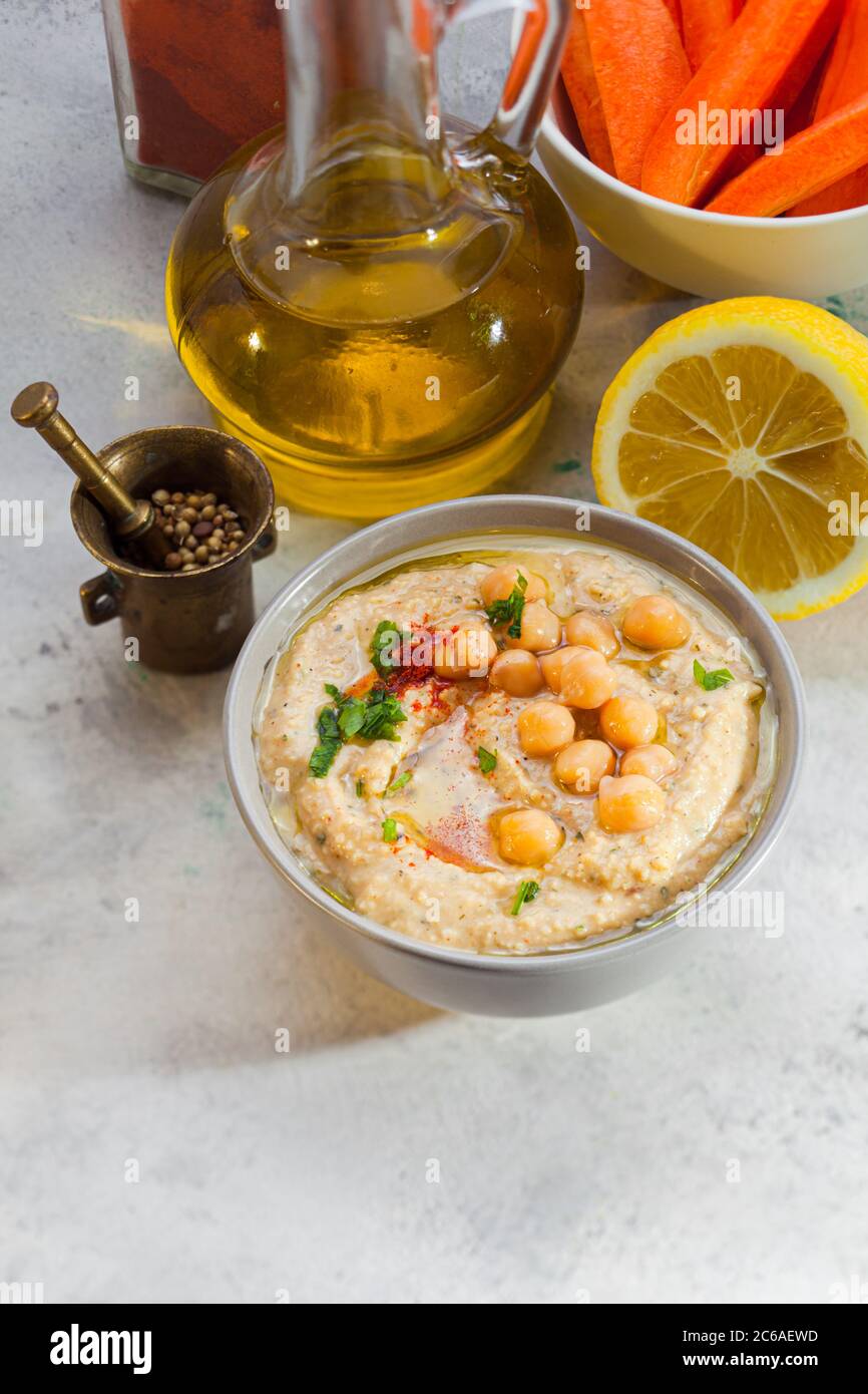 Hummus paste with ingredients on white surface Stock Photo - Alamy