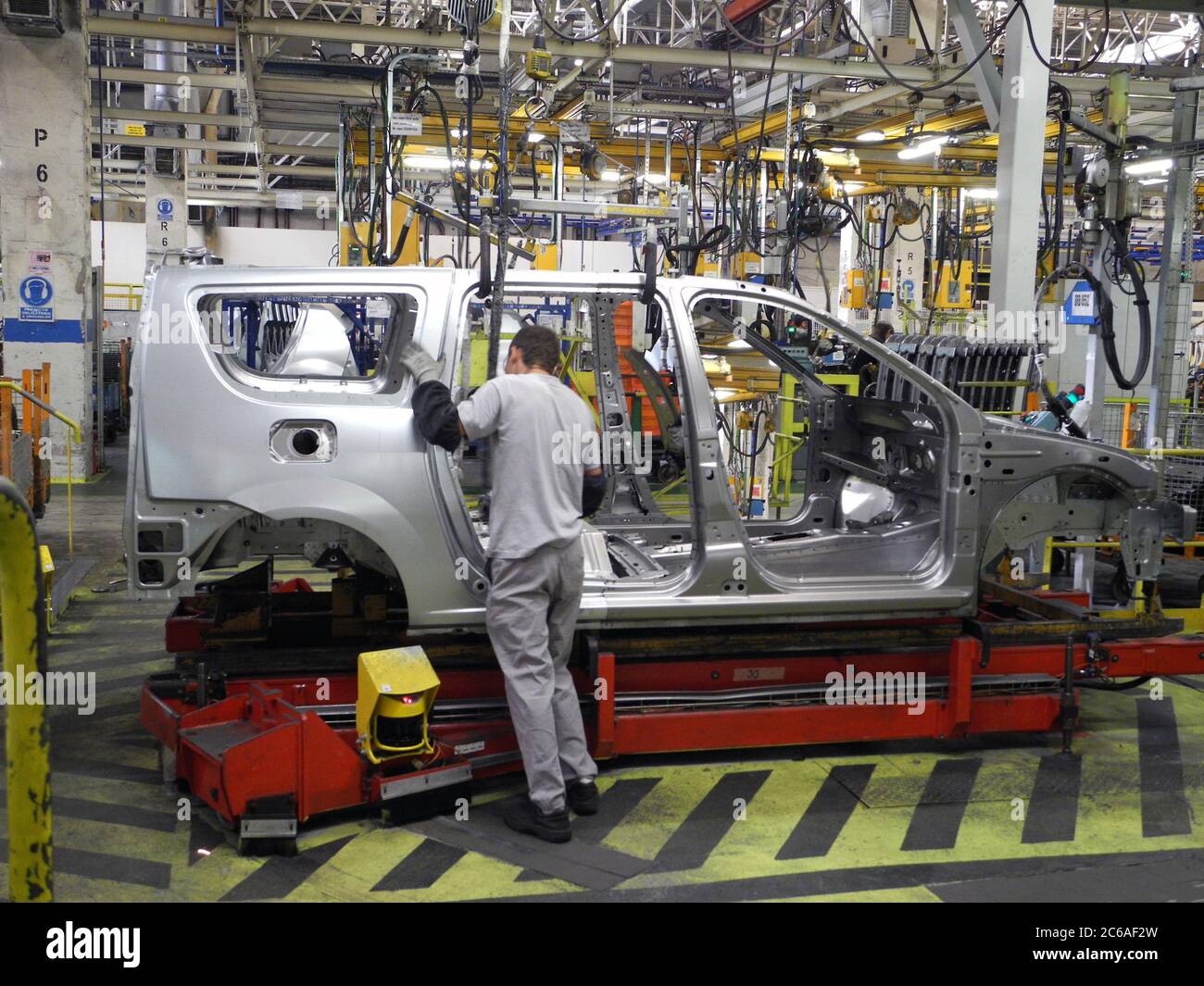 Car production line with unfinished cars in a row Stock Photo - Alamy