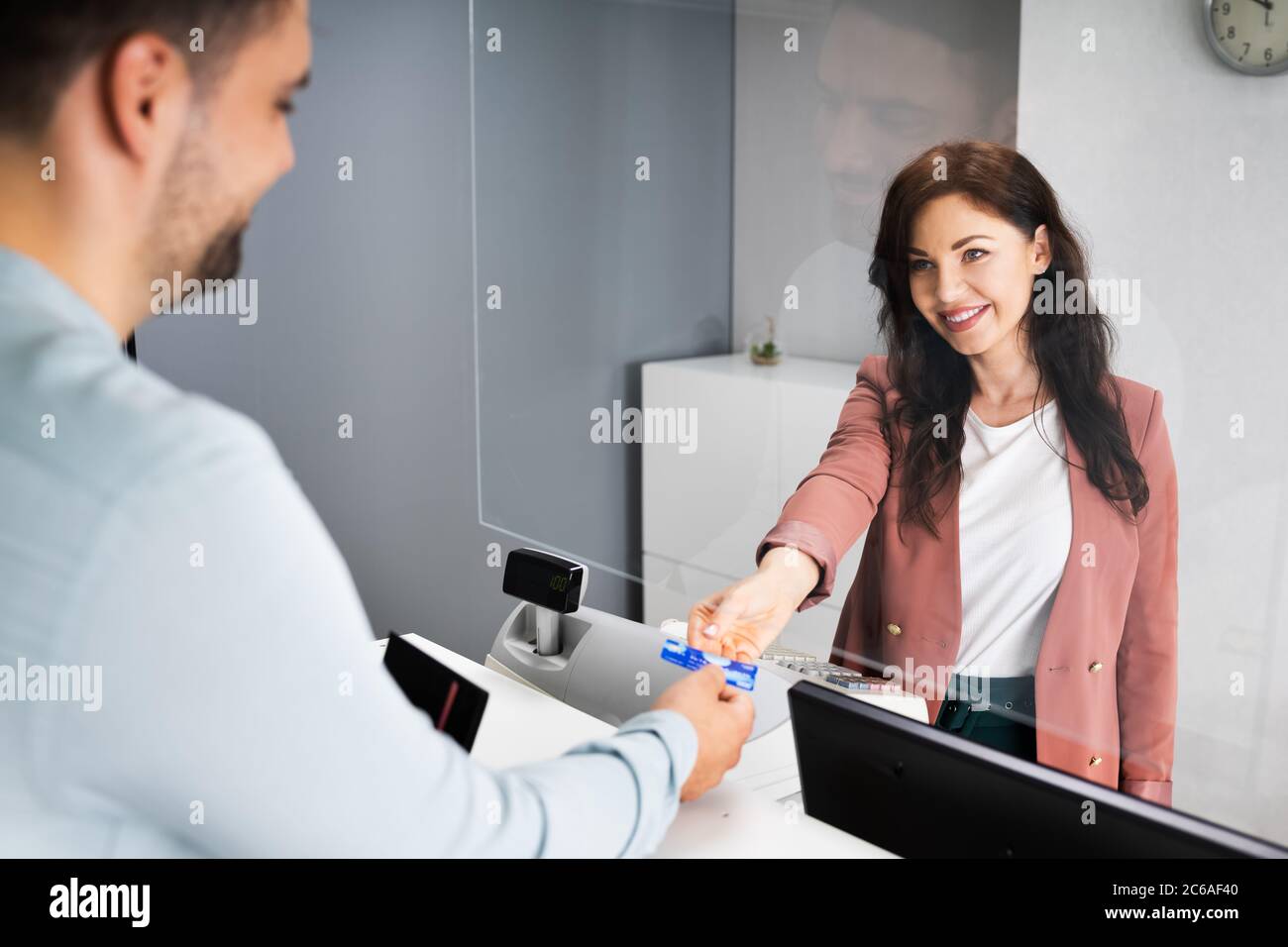 Shop Cashier In Store Or Hotel Reception Taking Credit Card Stock Photo ...