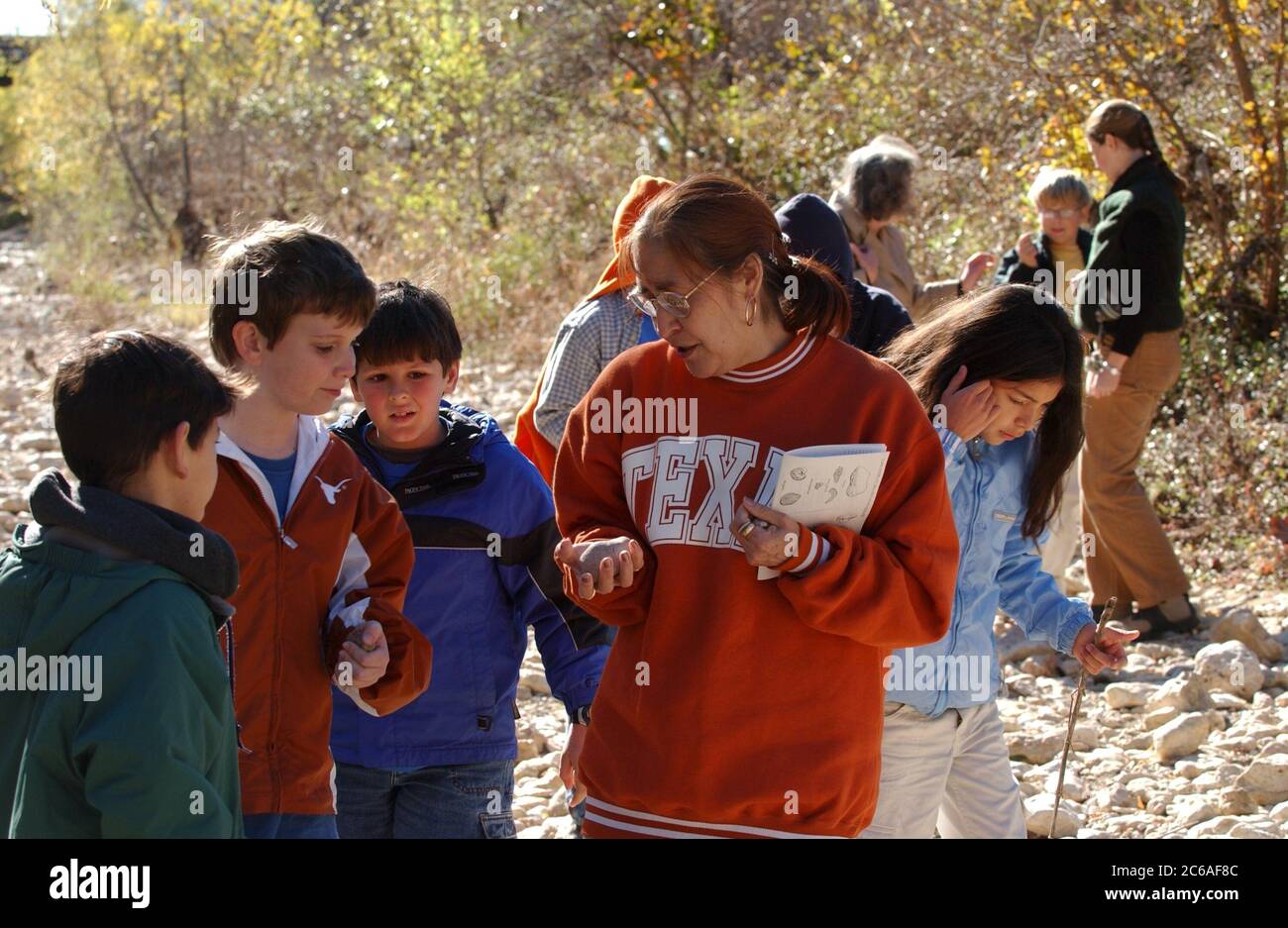 Austin, Texas USA, 2004: Veteran Hispanic teacher shows a rock to her ...