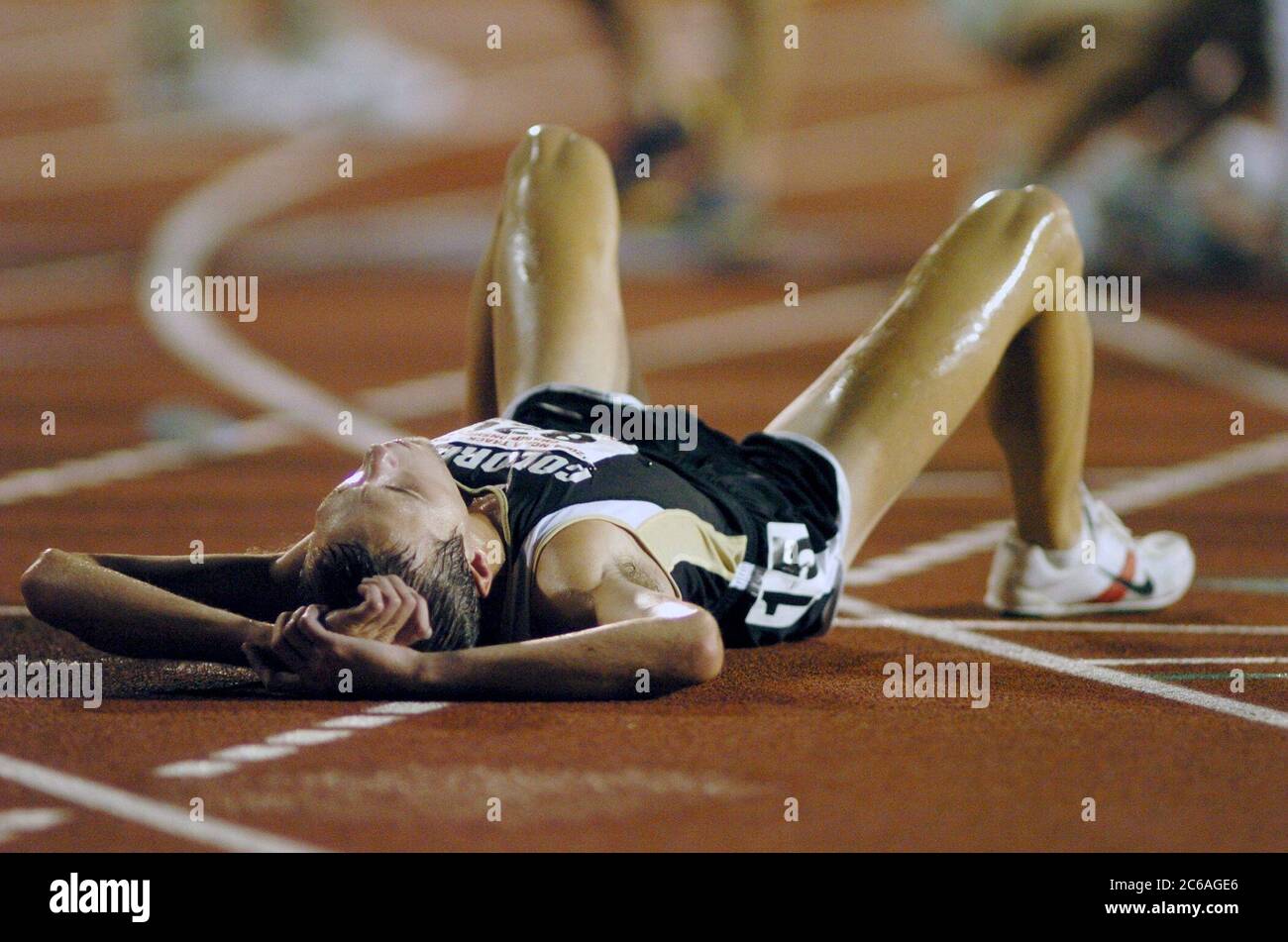 Austin Texas USA, June 2004: Male athlete collapses on the track in ...
