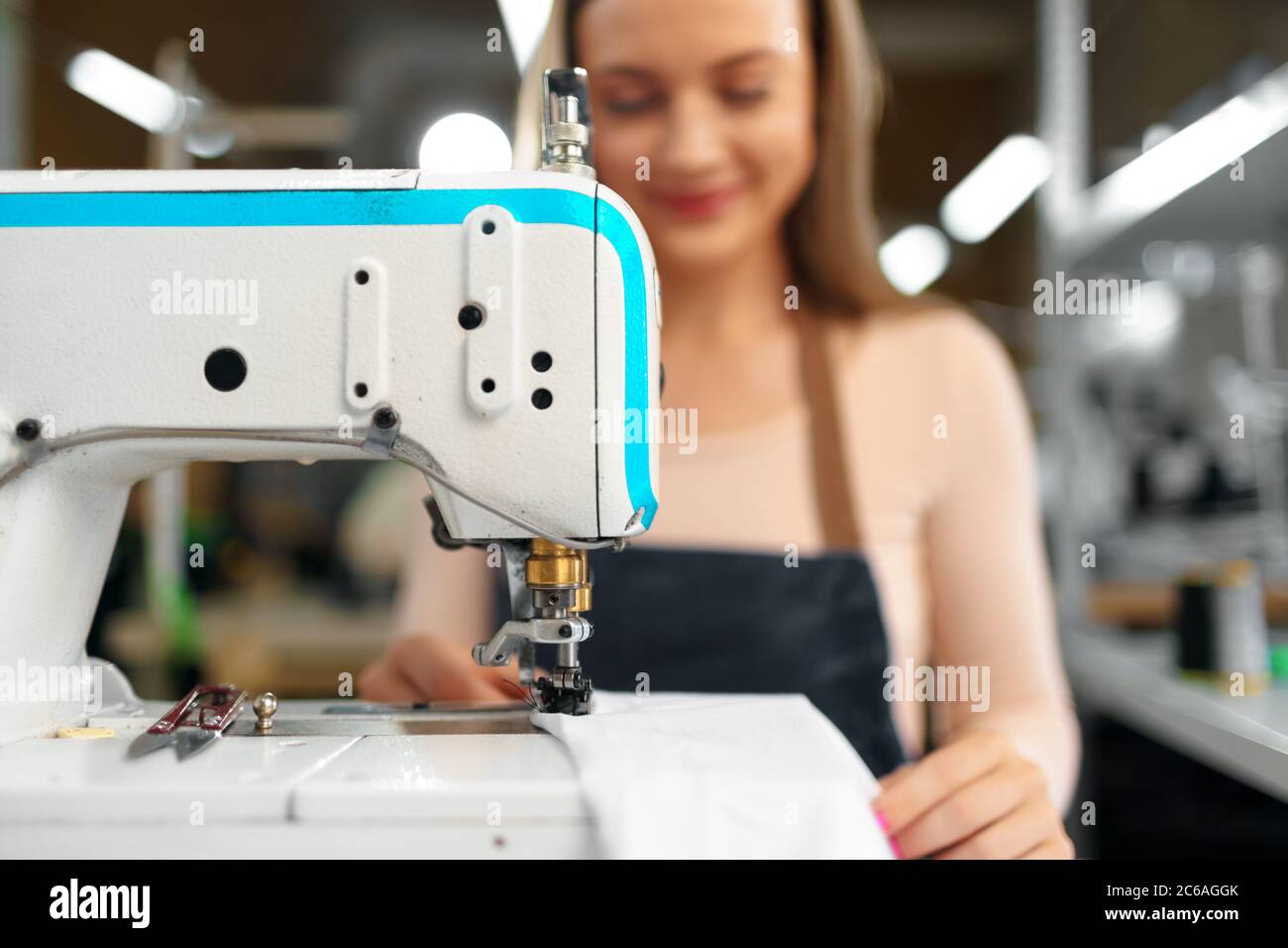 Portrait of seamstress working with sewing machine Stock Photo - Alamy