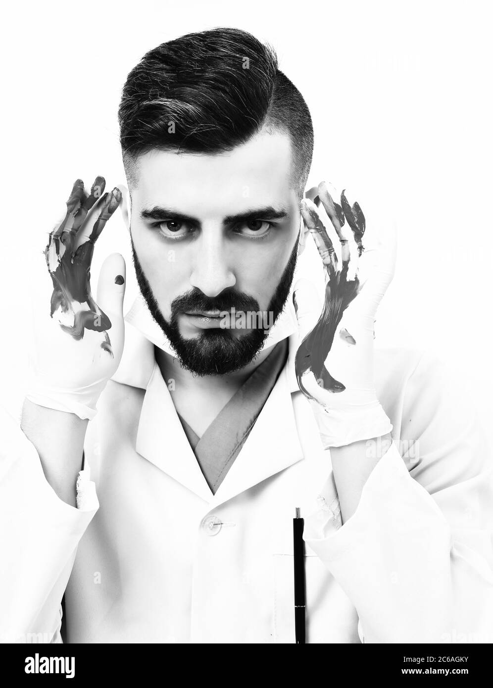 Doctor with beard and mad face expression holds his bloody hands up ...