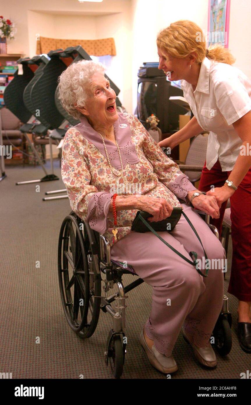 Austin, Texas USA, October 19 2004: Elderly woman in a wheelchair chats ...