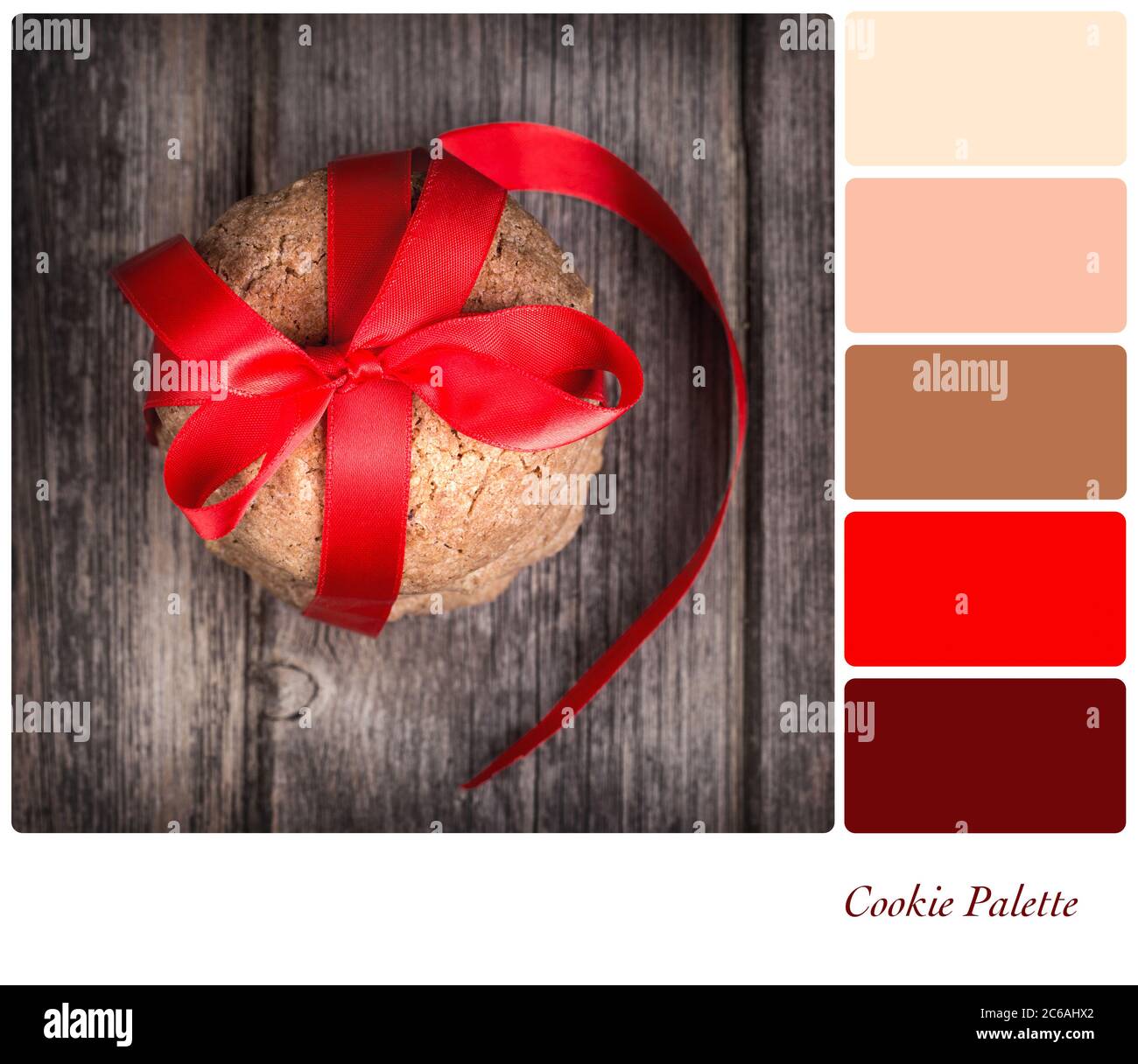 Homemade cookies tied with a red ribbon, over old wood background. In a ...