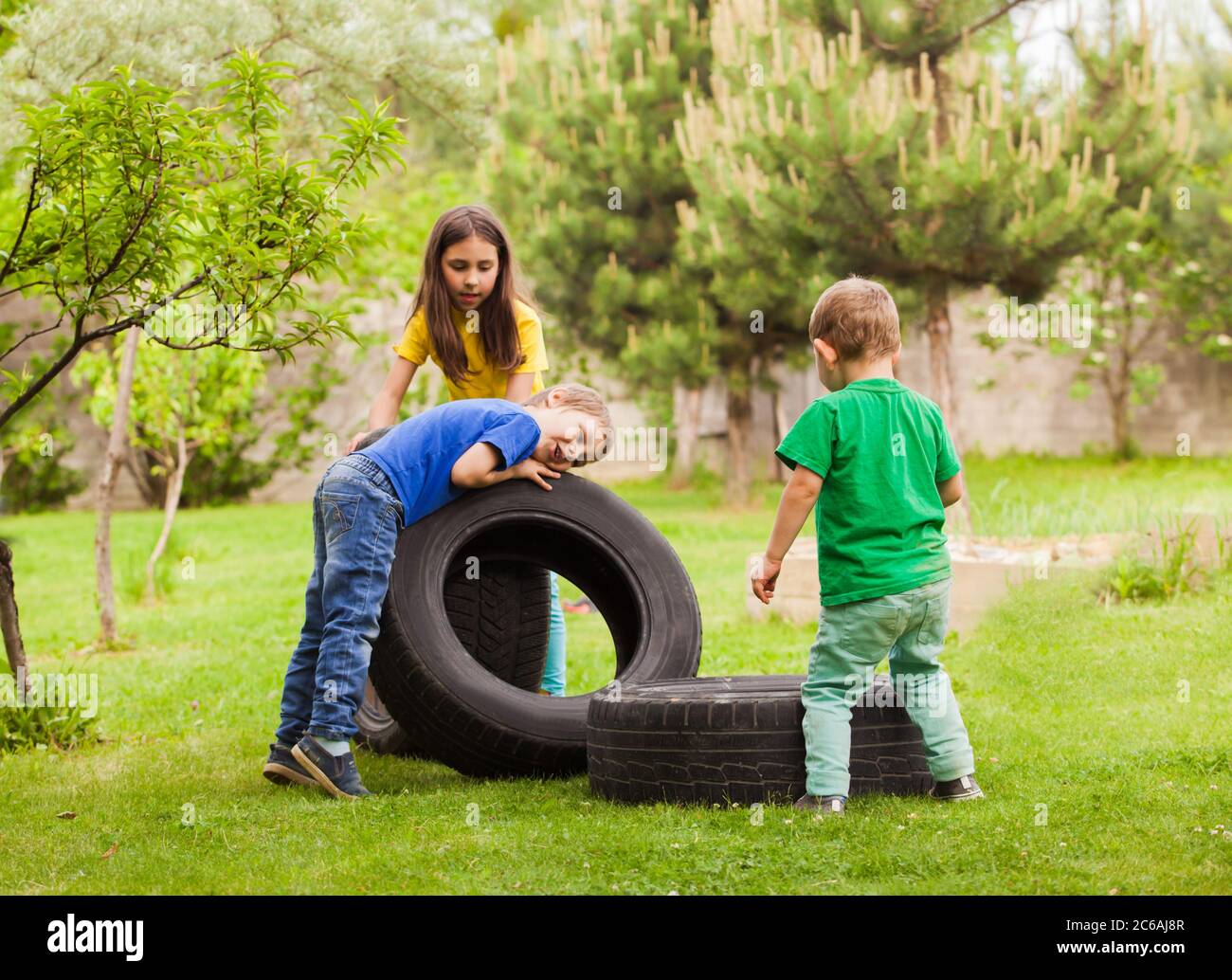 Boy rolling tire hi-res stock photography and images - Alamy