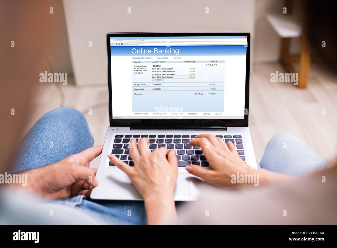 Couple Checking Bank Account Online On Couch Stock Photo - Alamy
