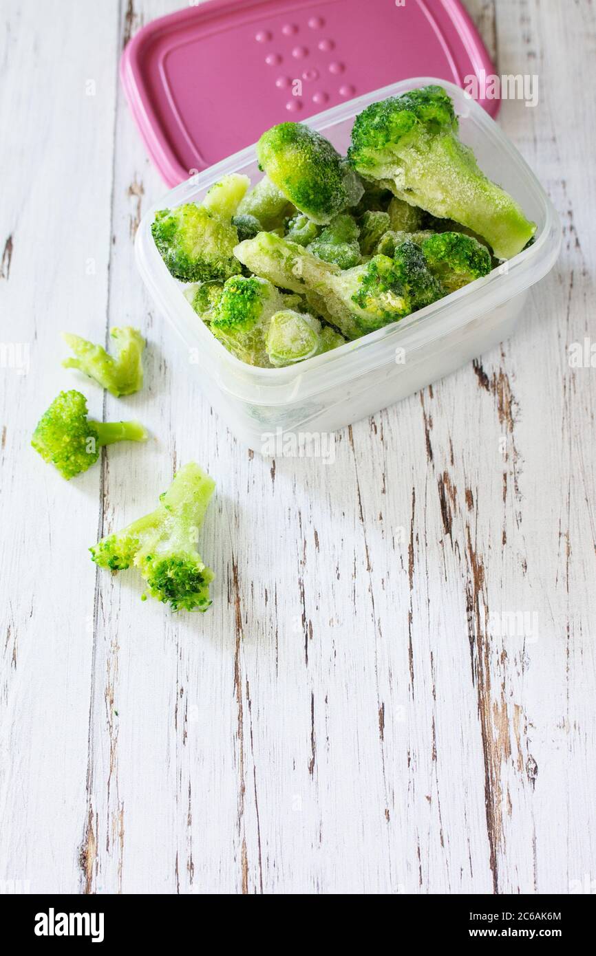 Healthy food is frozen. Containers with frozen broccoli. Copy space ...