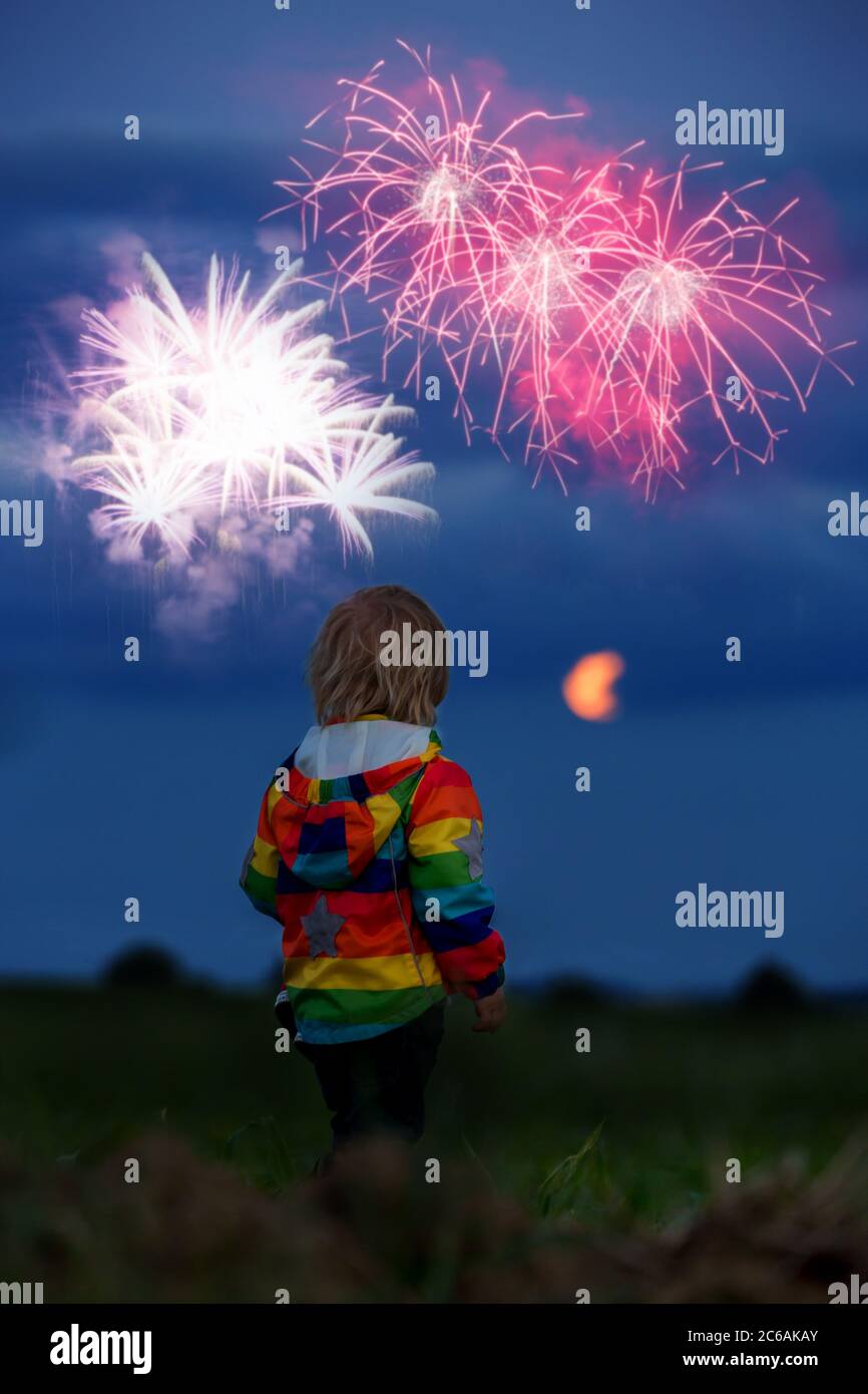 Happy toddler boy, child, looking at fireworks for 4th of July in a ...