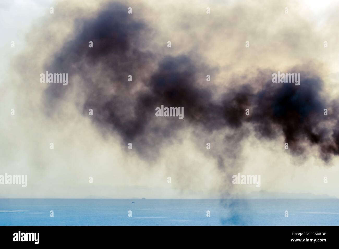 Exhaust pipe of ferry boat with black thick smoke coming out and sky ...