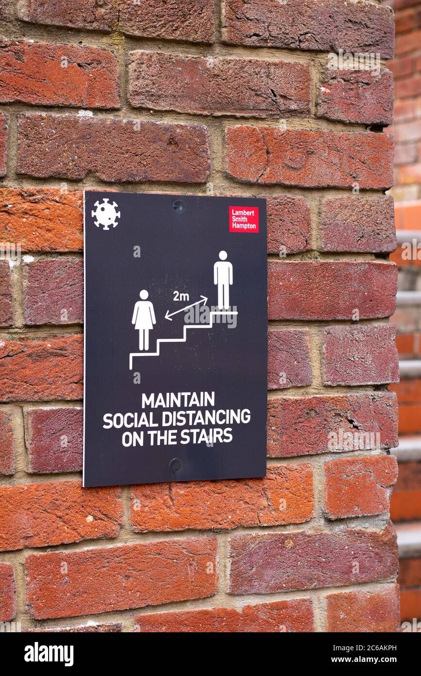 COVID 19 safety information sign for shoppers mounted on brick wall ...