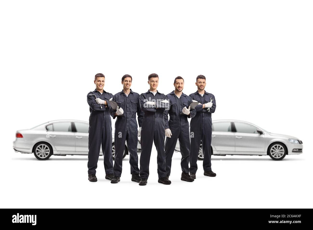 Five auto mechanic workers in uniforms standing in a group in front of ...