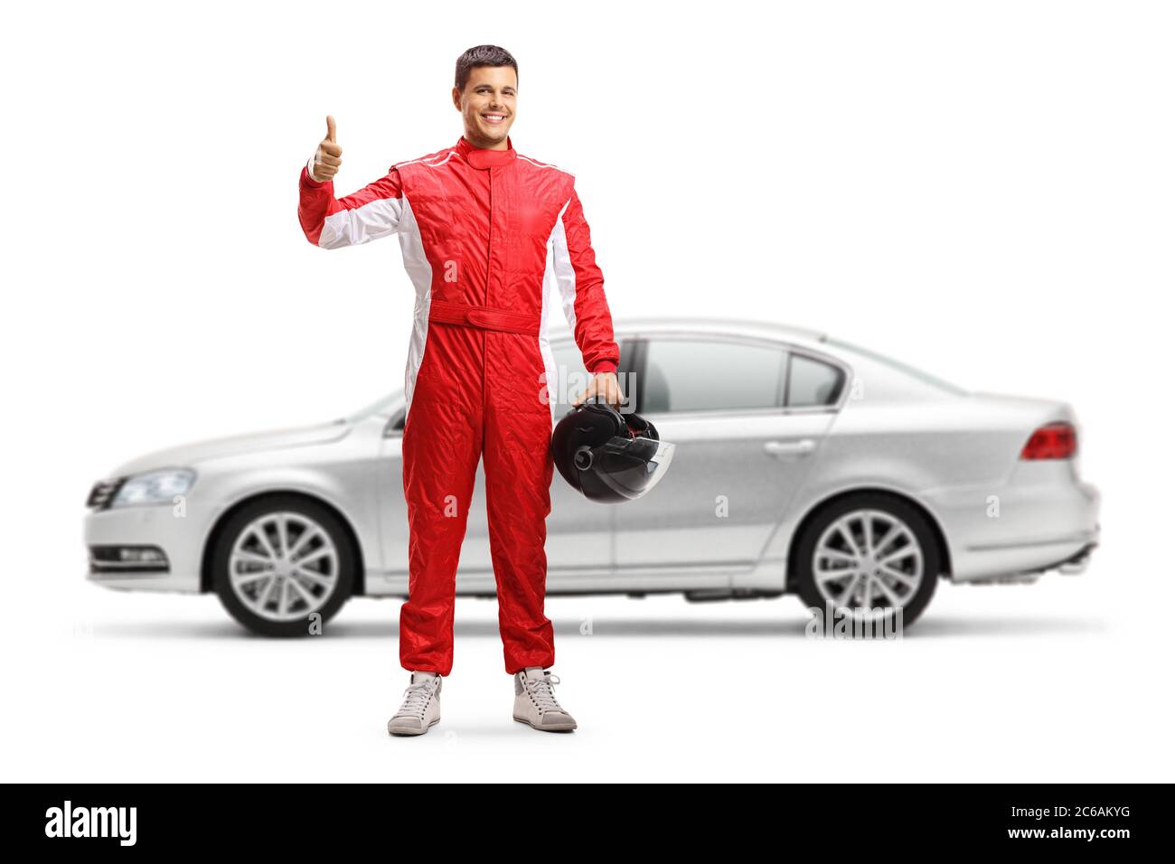 Full length portrait of a car racer in front of a silver car showing ...