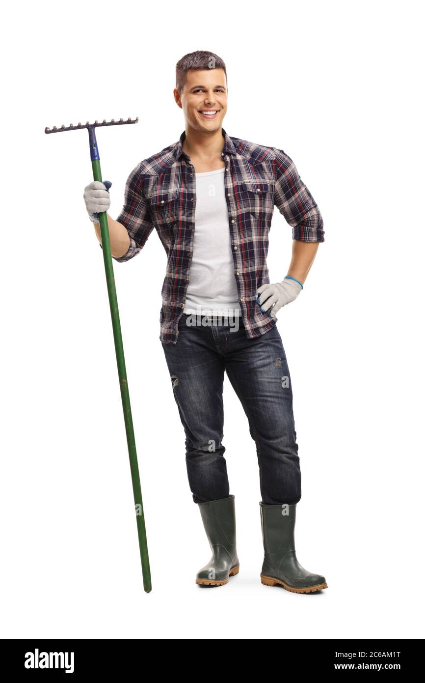 Full length portrait of a cheerful young farmer holding a rake isolated ...