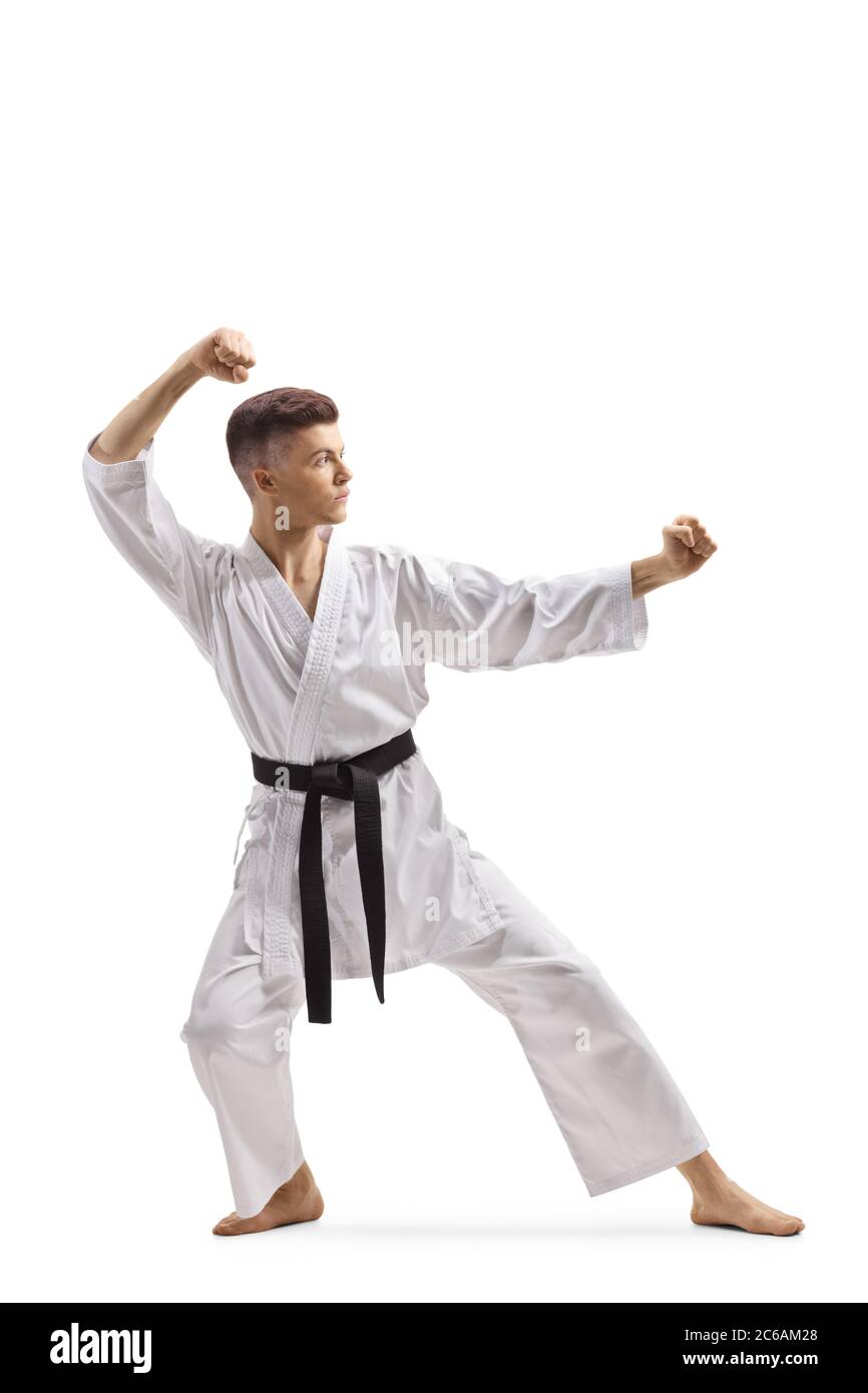 Full length shot of a young man in kimono practicing karate isolated on ...