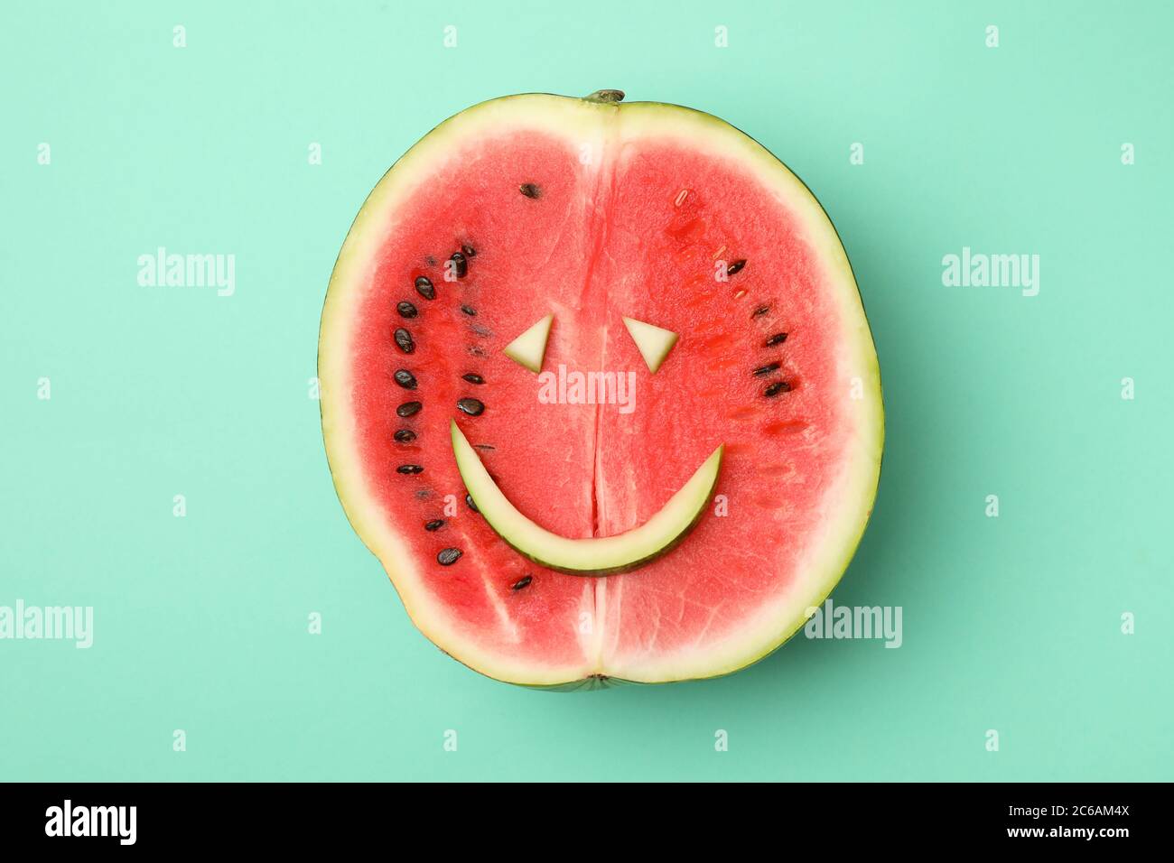 Watermelon with smiley face on mint background, top view Stock Photo ...