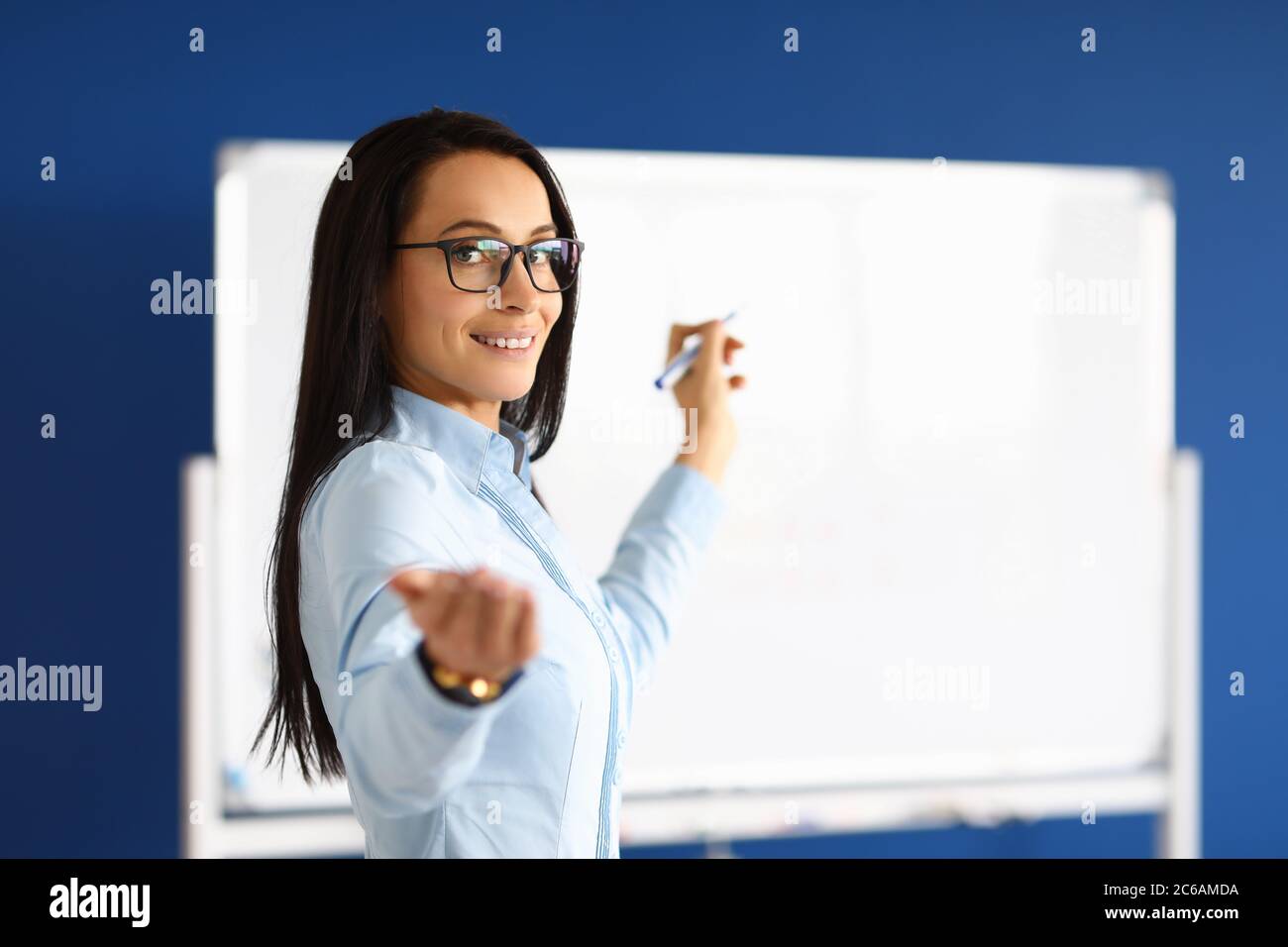 Beautiful young woman giving presentation Stock Photo - Alamy
