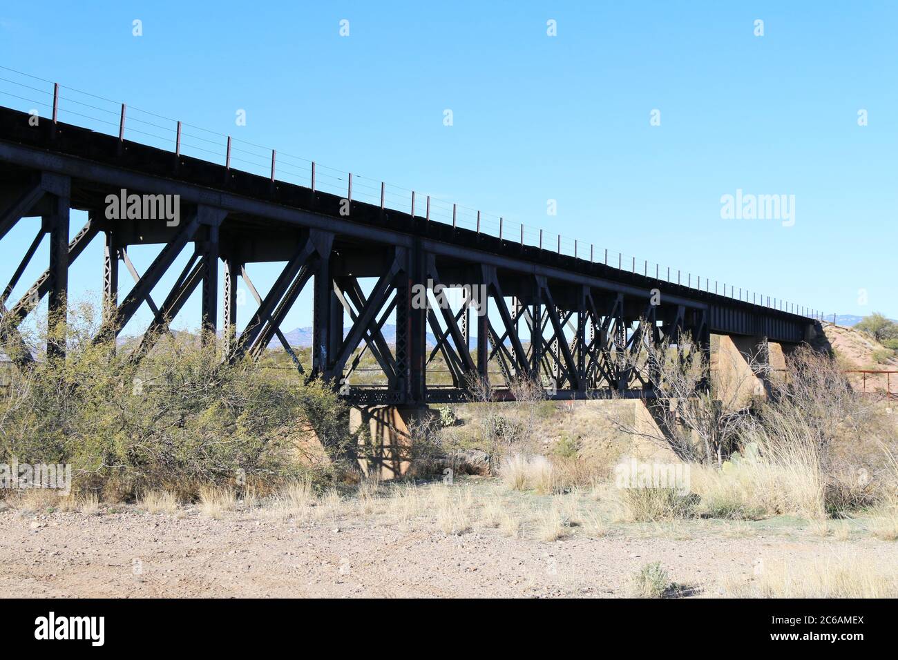 a tall railway bridge over a desert gorge with blue sky Stock Photo - Alamy