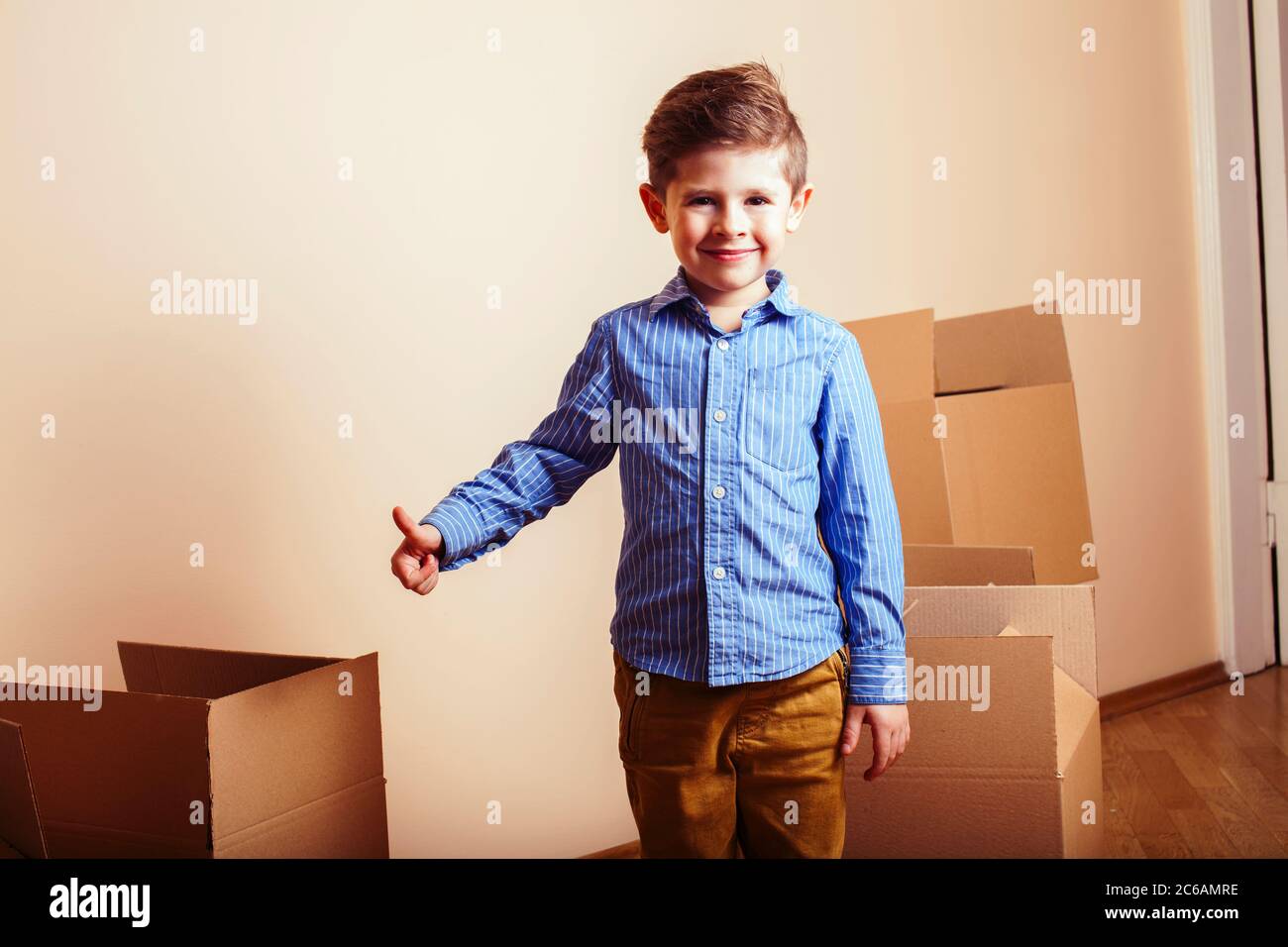 little cute boy in empty room, move to new house. home alone among ...