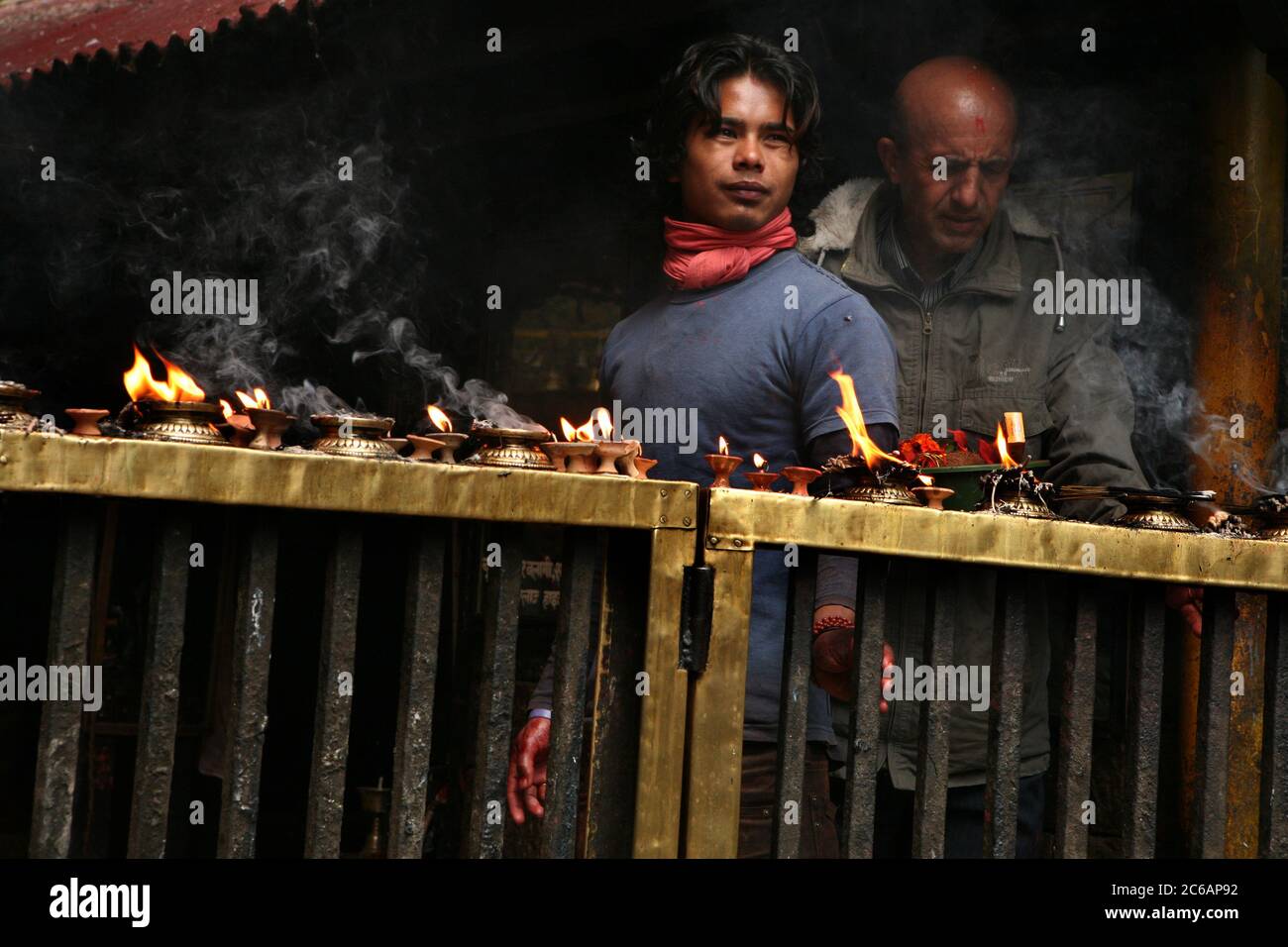 Ritual slaughter rests after animal sacrifices with blood on his hands ...