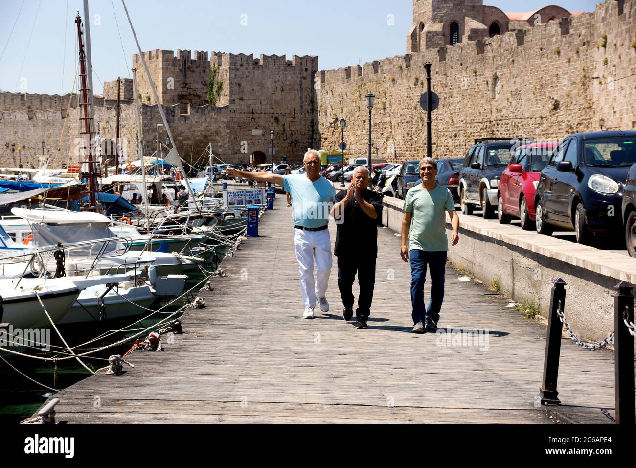 Three men in Greece are happy and happy. Greek men. Greek hospitality ...