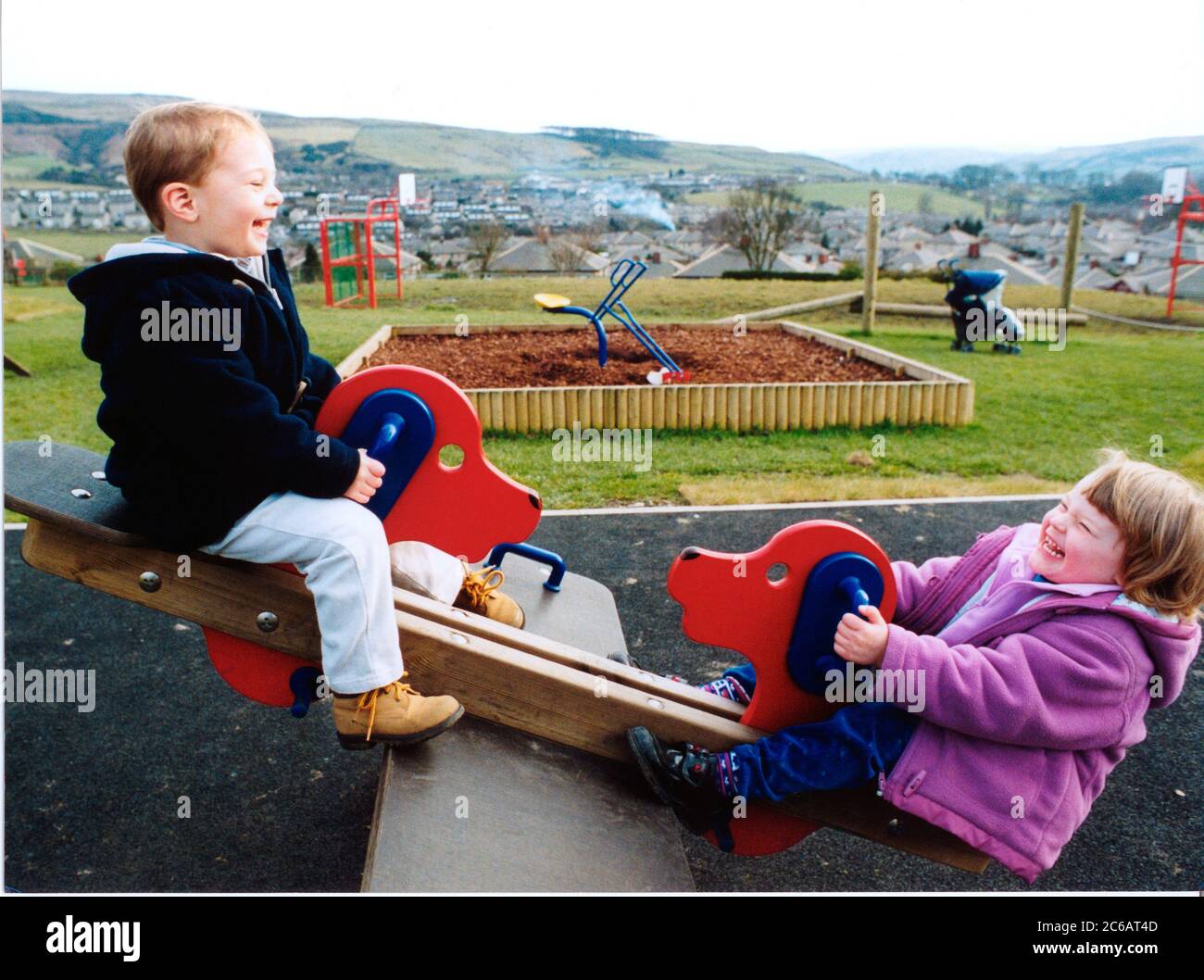 Small children playing on seesaw in North Yorkshire Stock Photo - Alamy