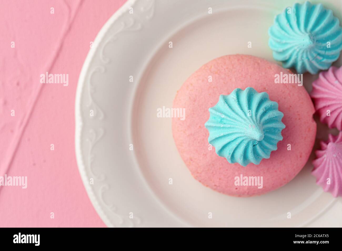 French macaroon cookies of bright colors served in white ceramic plate ...