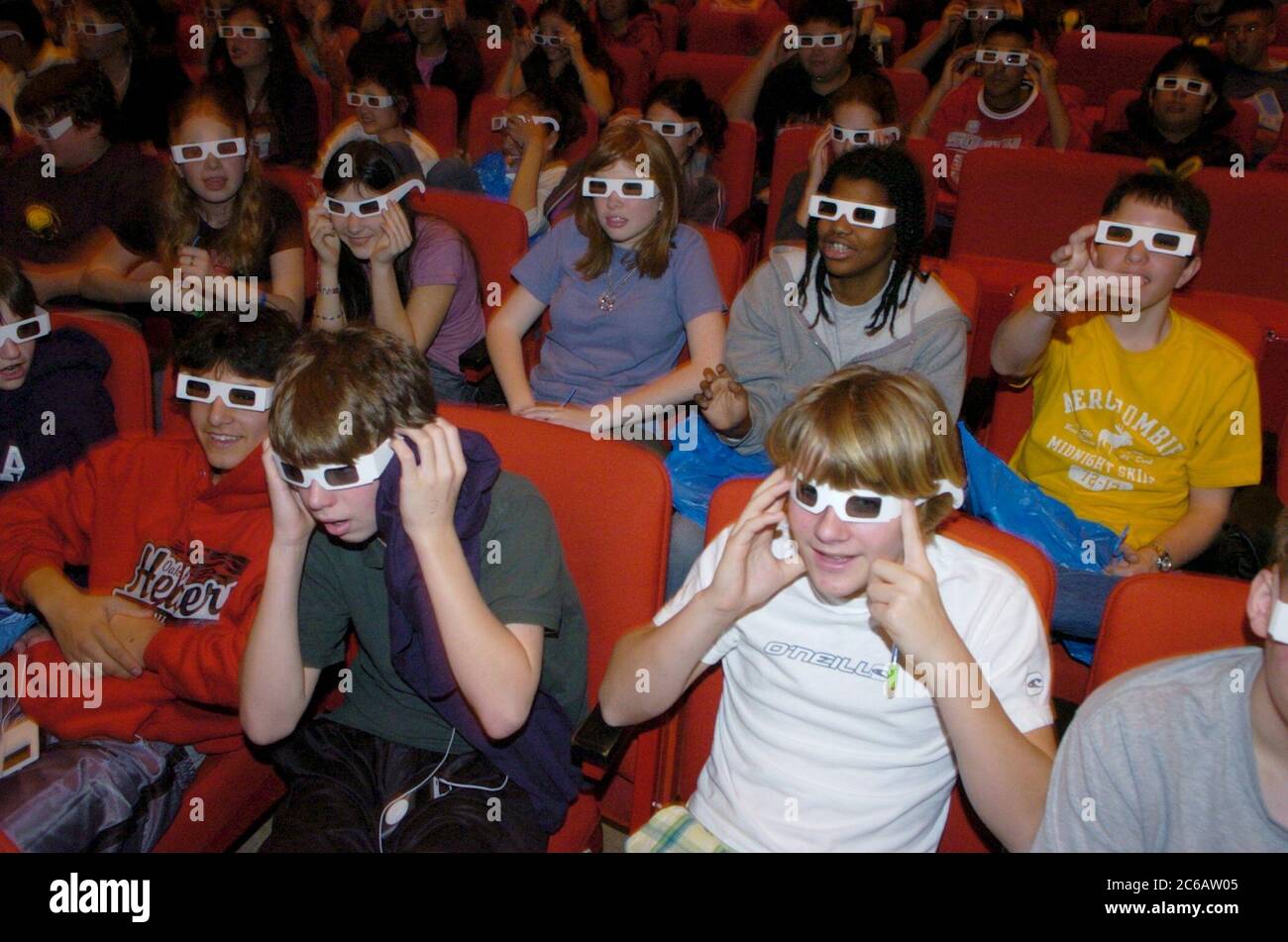 Junior high school students wear disposable 3-D glasses while watching ...