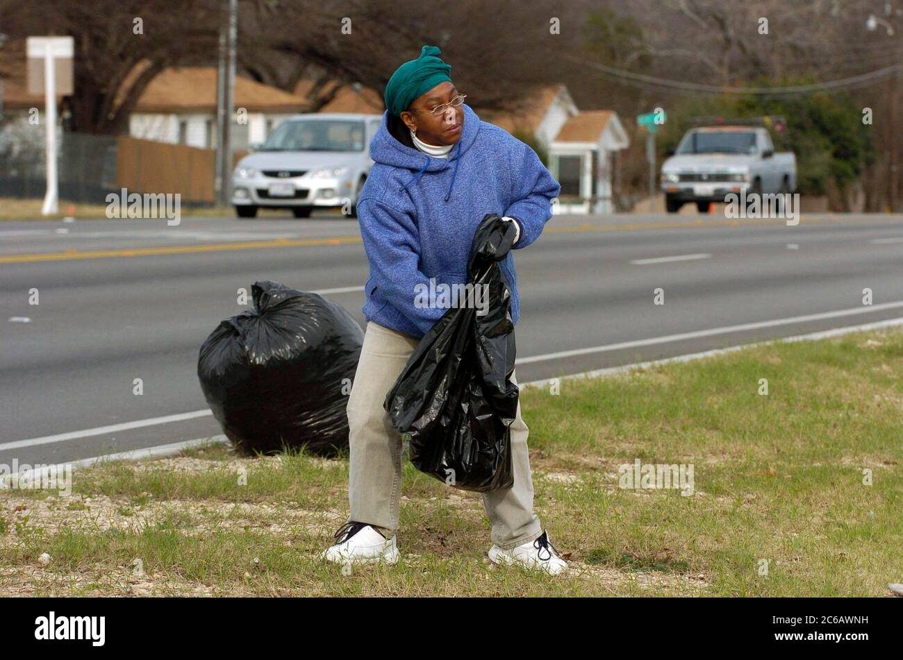 Austin, Texas USA, January 15, 2005: Volunteer helps clean up trash ...