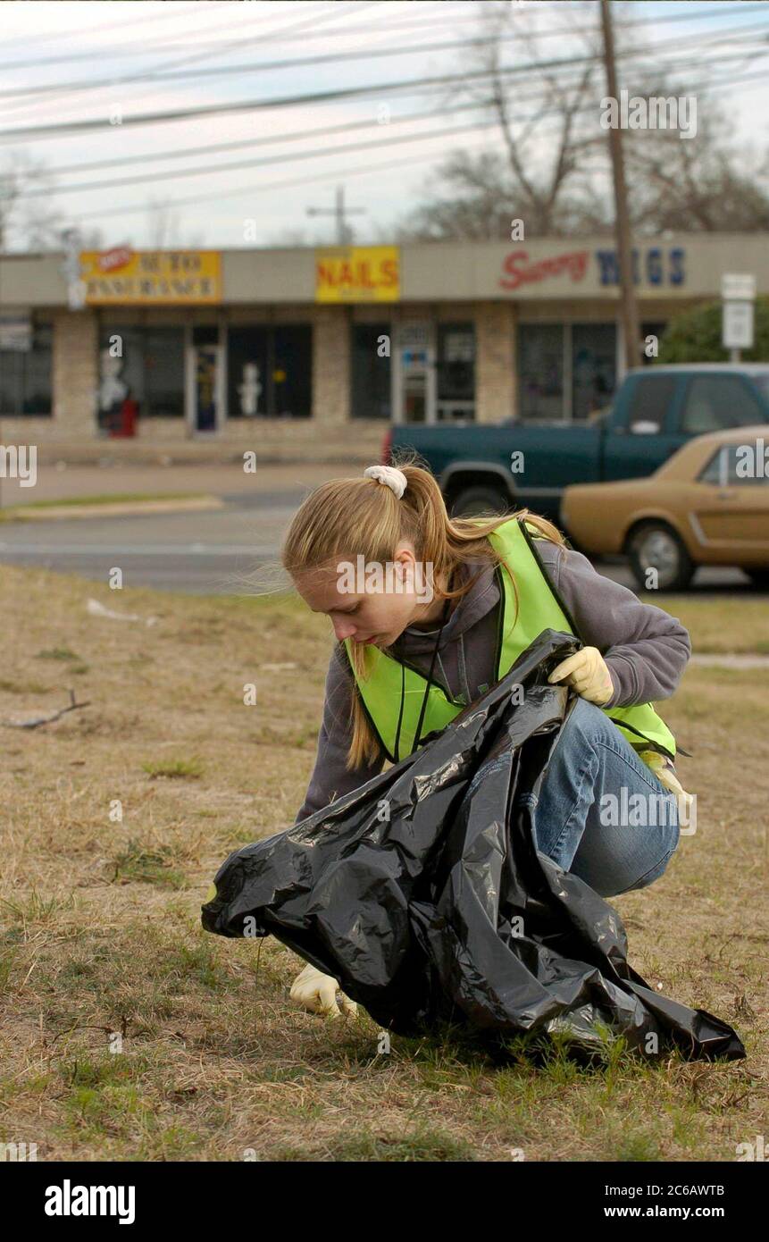 Austin, Texas USA, January 15, 2005: Volunteer helps clean up trash ...
