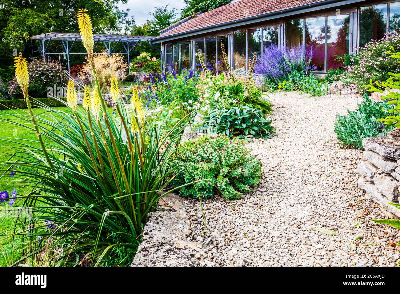 Terraced herbaceous borders in a sloping country garden Stock Photo - Alamy