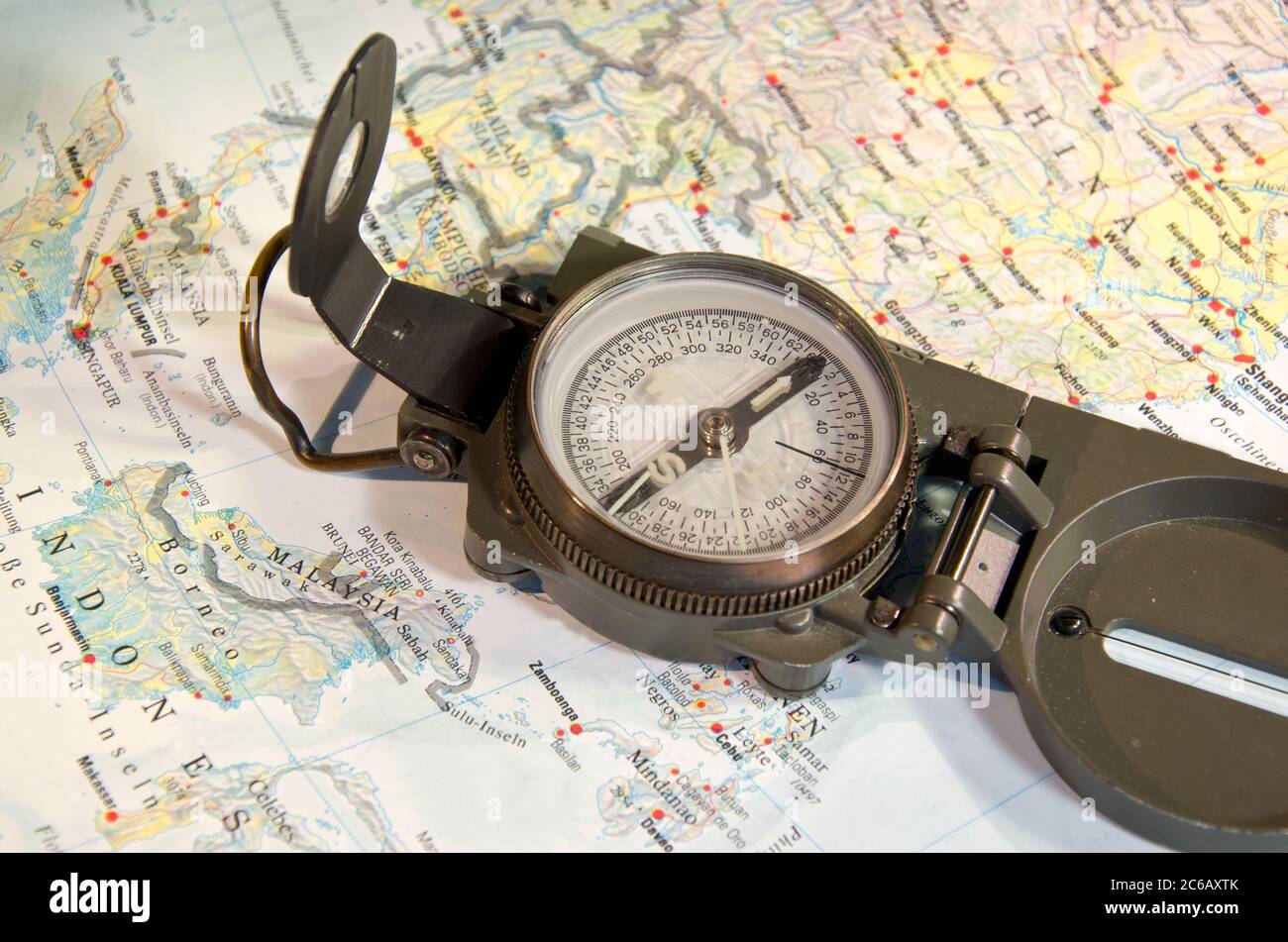 Compass lying on world map Stock Photo - Alamy