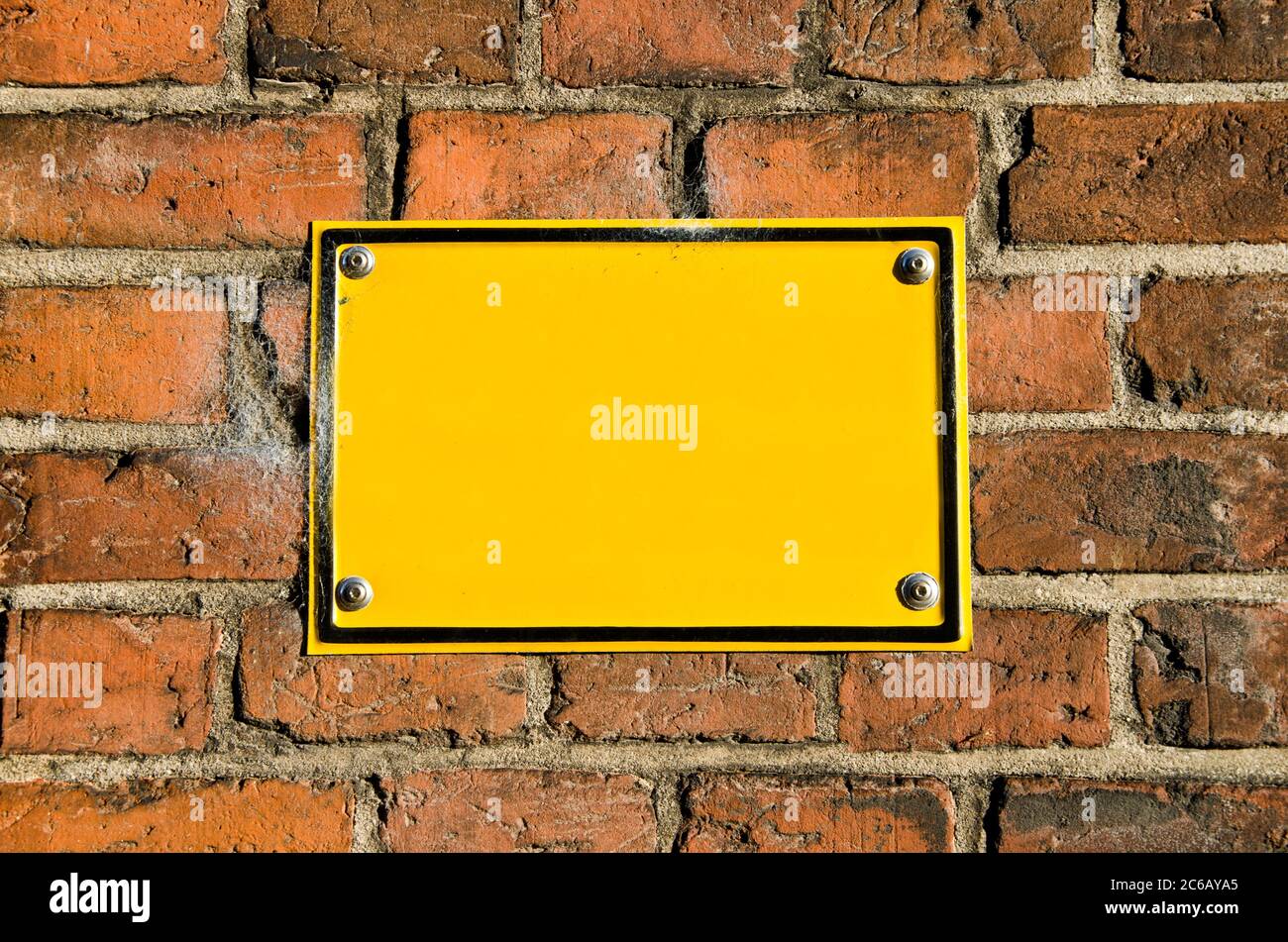 Blank yellow metal signboard on red brick wall Stock Photo - Alamy